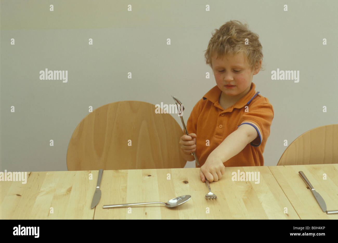 little boy setting the table Stock Photo - Alamy