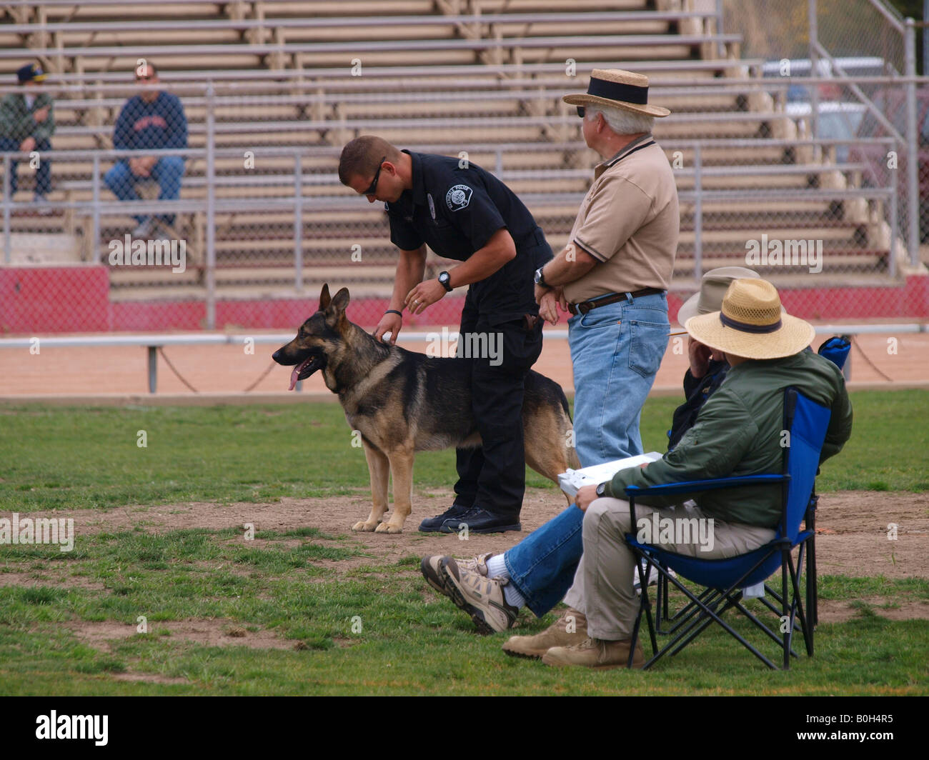 Police officer prepares to release his dog in the first phase of the K9 ...