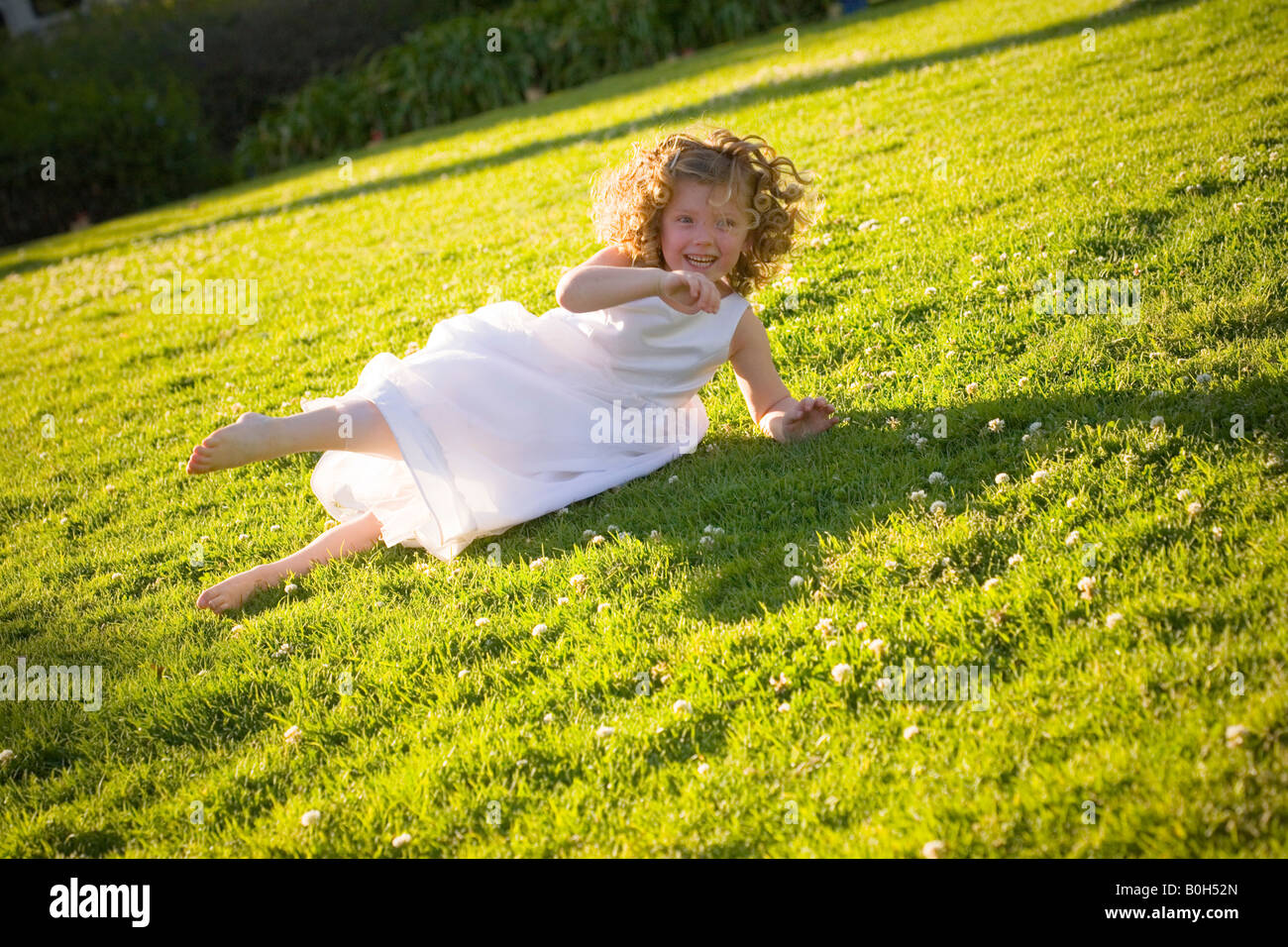 Girl rolling down hill hi-res stock photography and images - Alamy