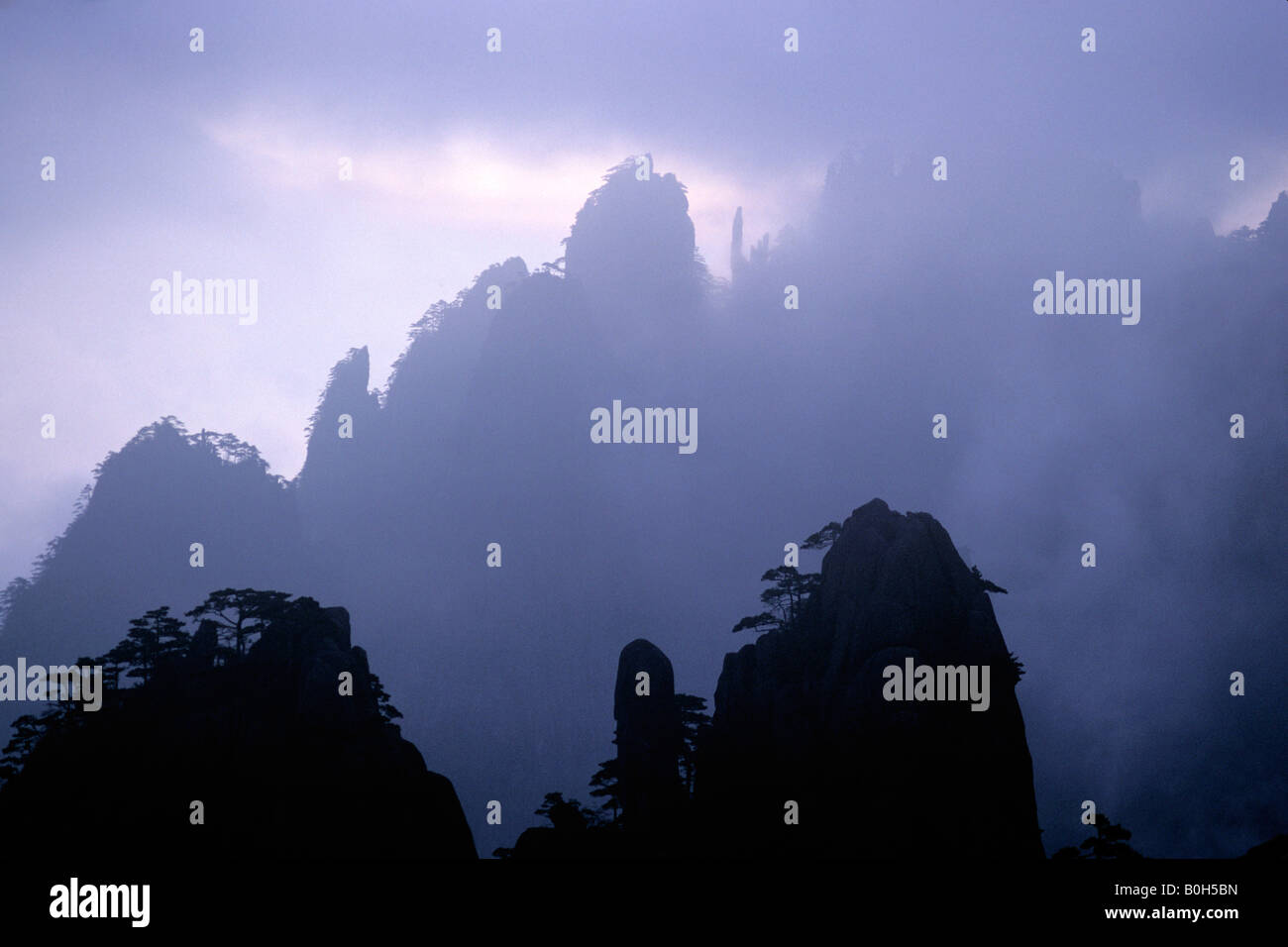 Sun breaking through mist on Huangshan Anhui Province China Stock Photo ...