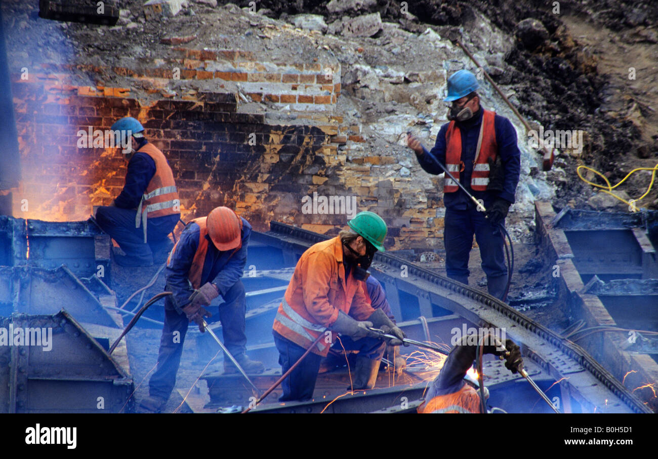welders deconstruct a steel joist of an old bridge Stock Photo - Alamy
