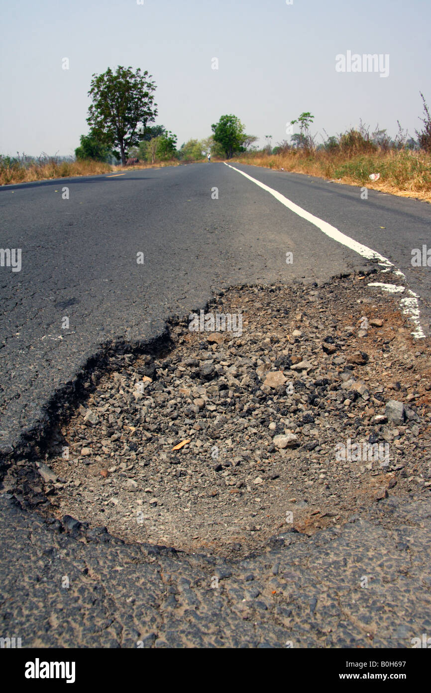 Potholed road Thailand Stock Photo - Alamy