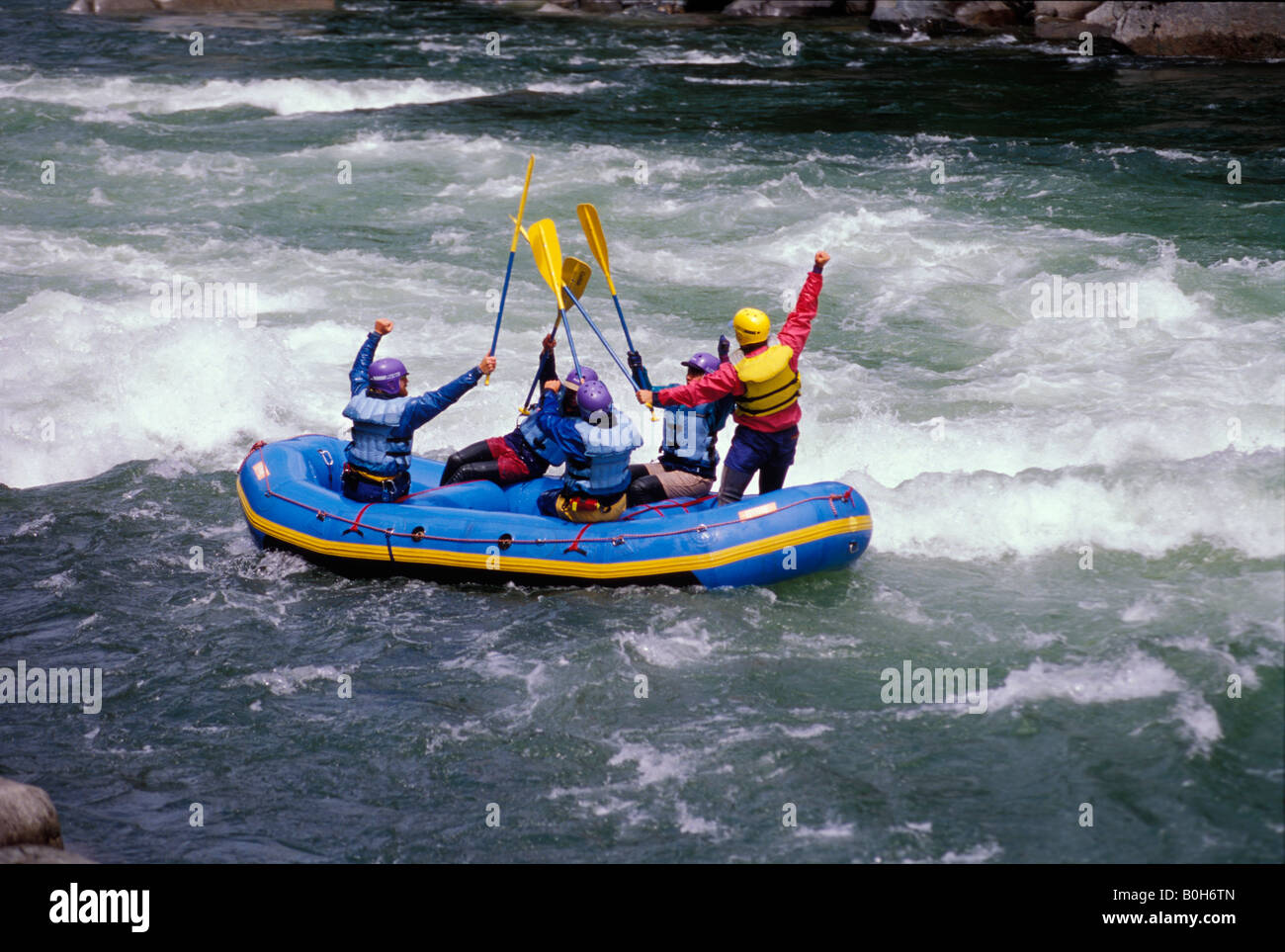 The crew of a river raft celebrates the successful trip through a ...