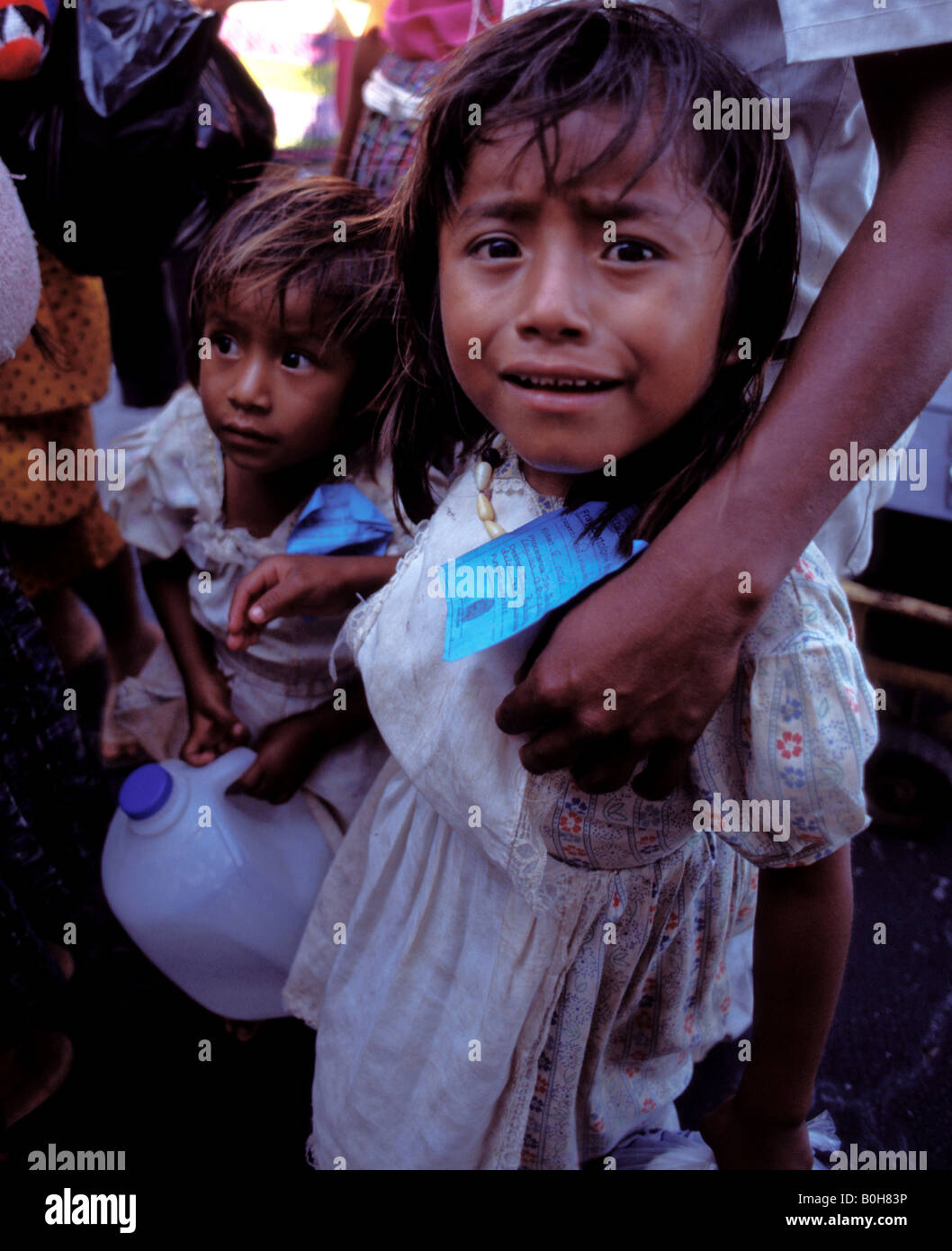 Young mayan girls with their parents as they return from Guatemala from ...