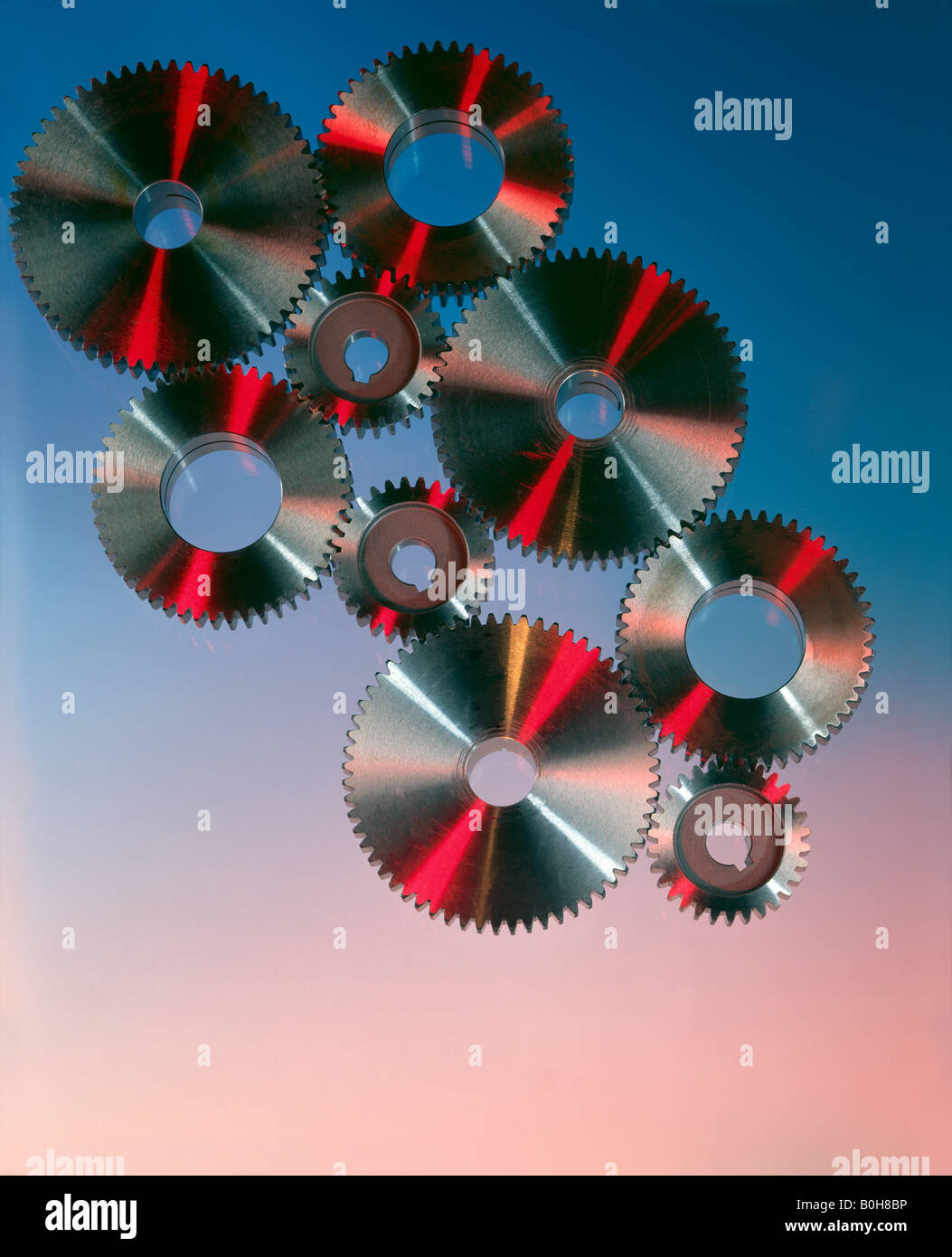 Illuminated red toothed wheels, cogwheels, gear wheels Stock Photo - Alamy