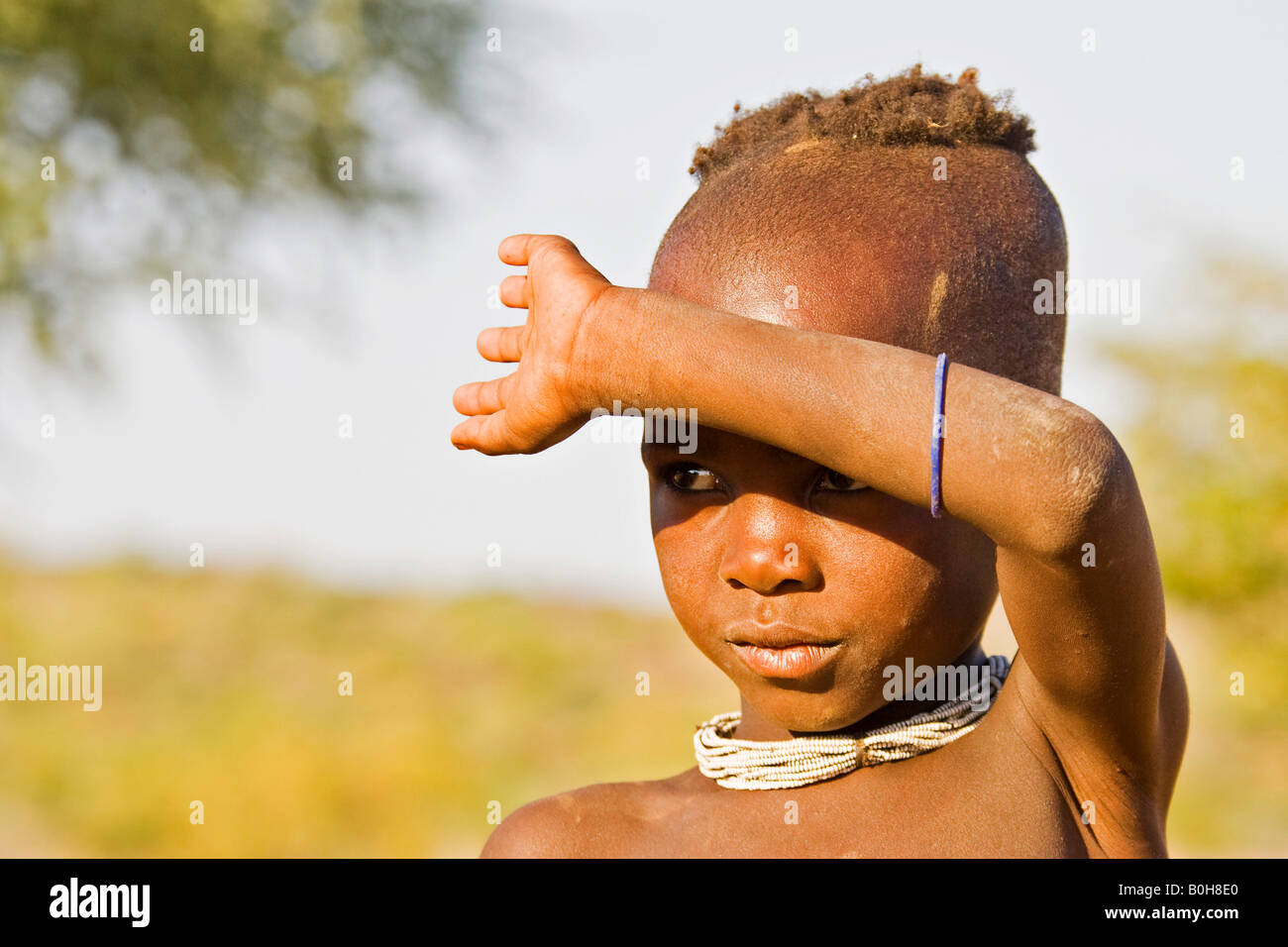 Himba boy shielding his eyes from the sun, Kaokoveld, Namibia, Africa ...