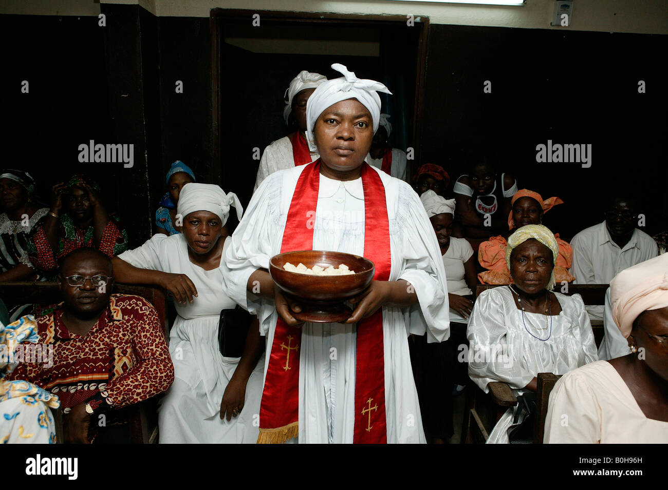 Woman distributing the bread sacrament during a church service in ...