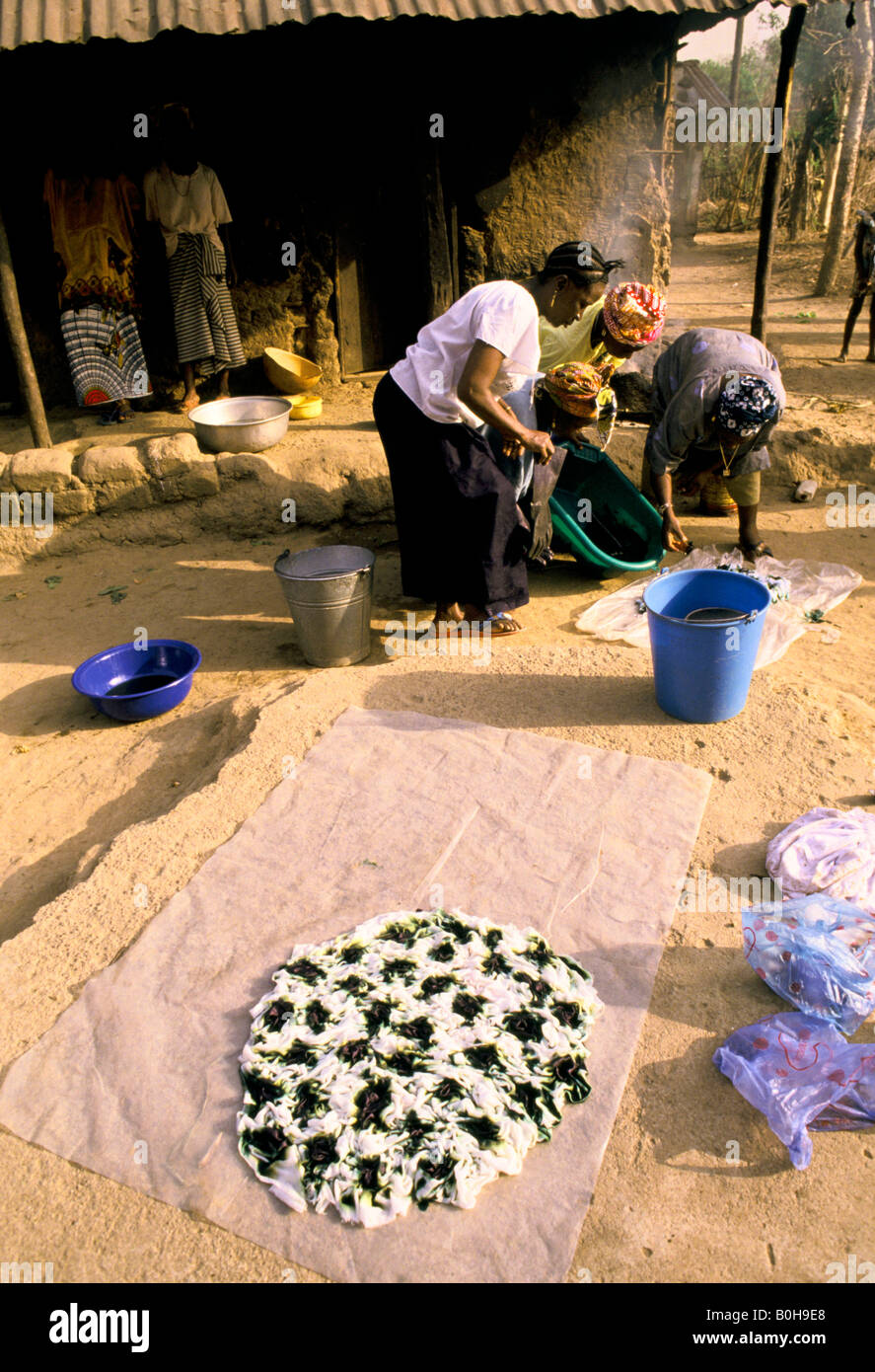 A group of women making traditional tie-dyed clothing, Gbonokobana ...