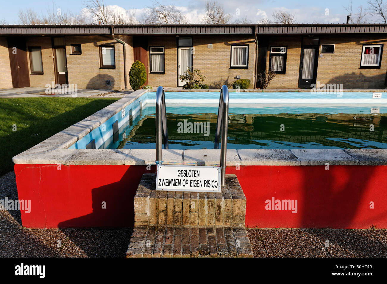 Red swimming pool at a summer cottage complex in Het Kustlicht ...