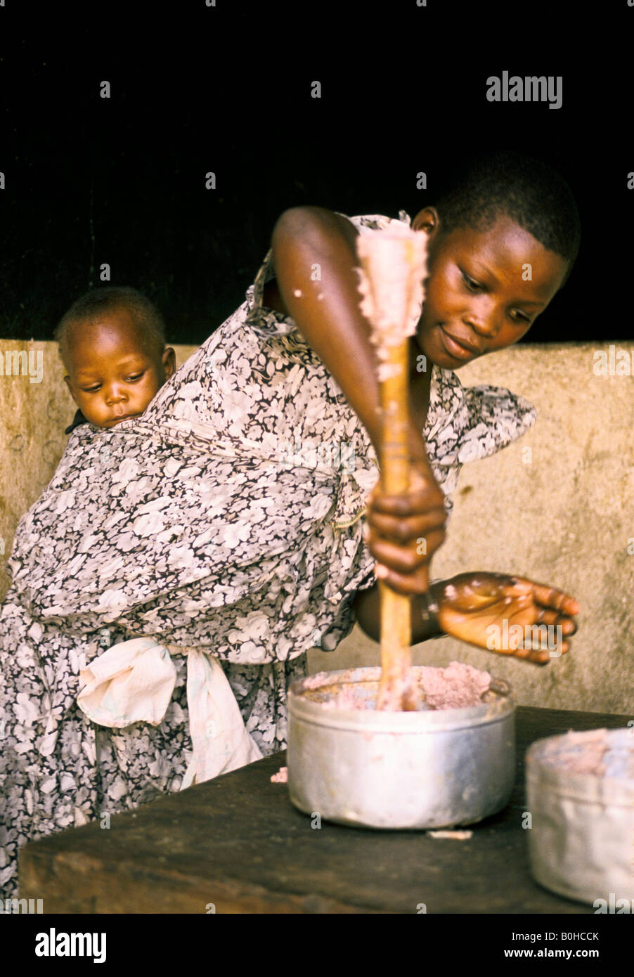 A woman preparing food for malnourished children at Mulago Hospital ...