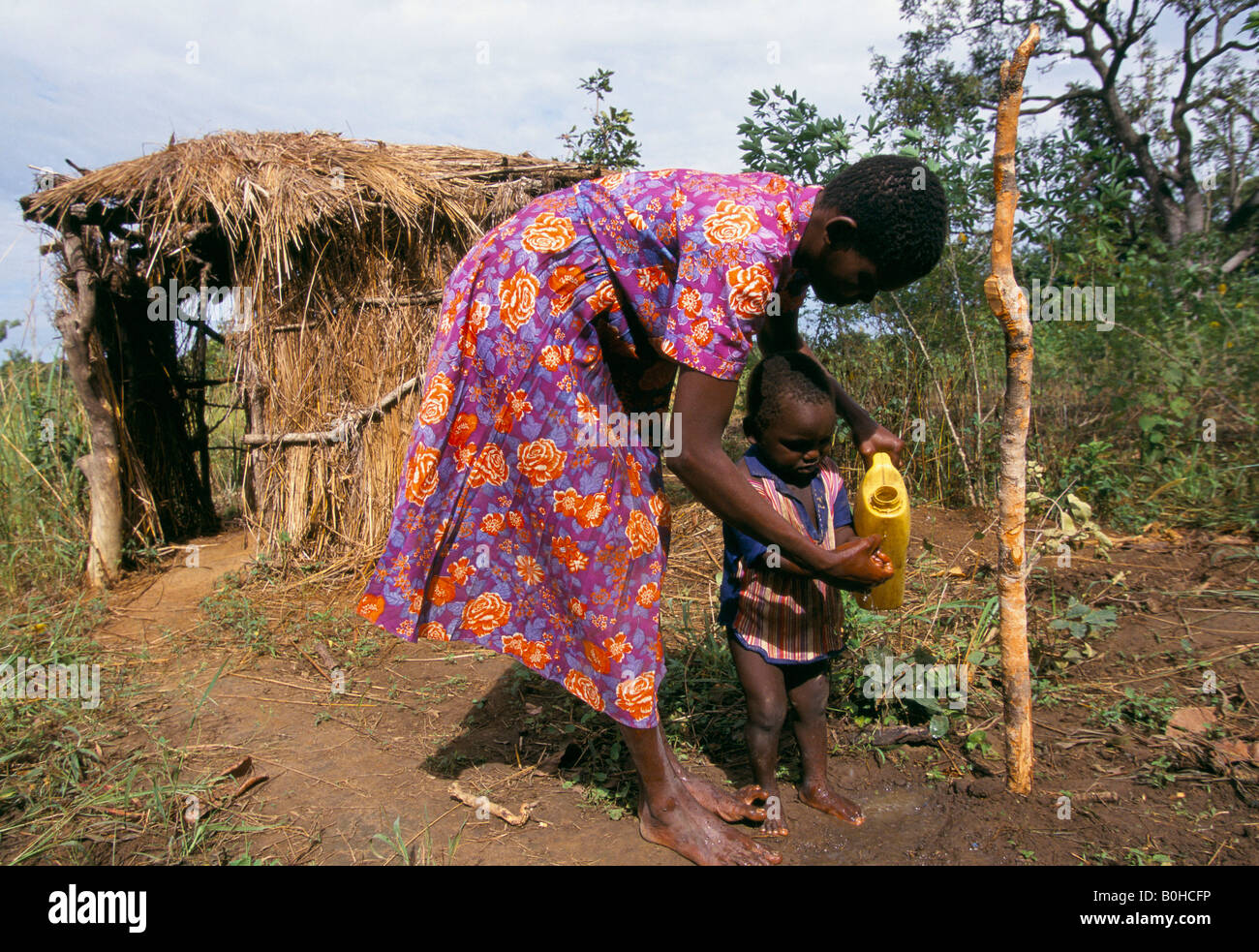 A mother and child washing their hands after using a latrine, Omadisa ...