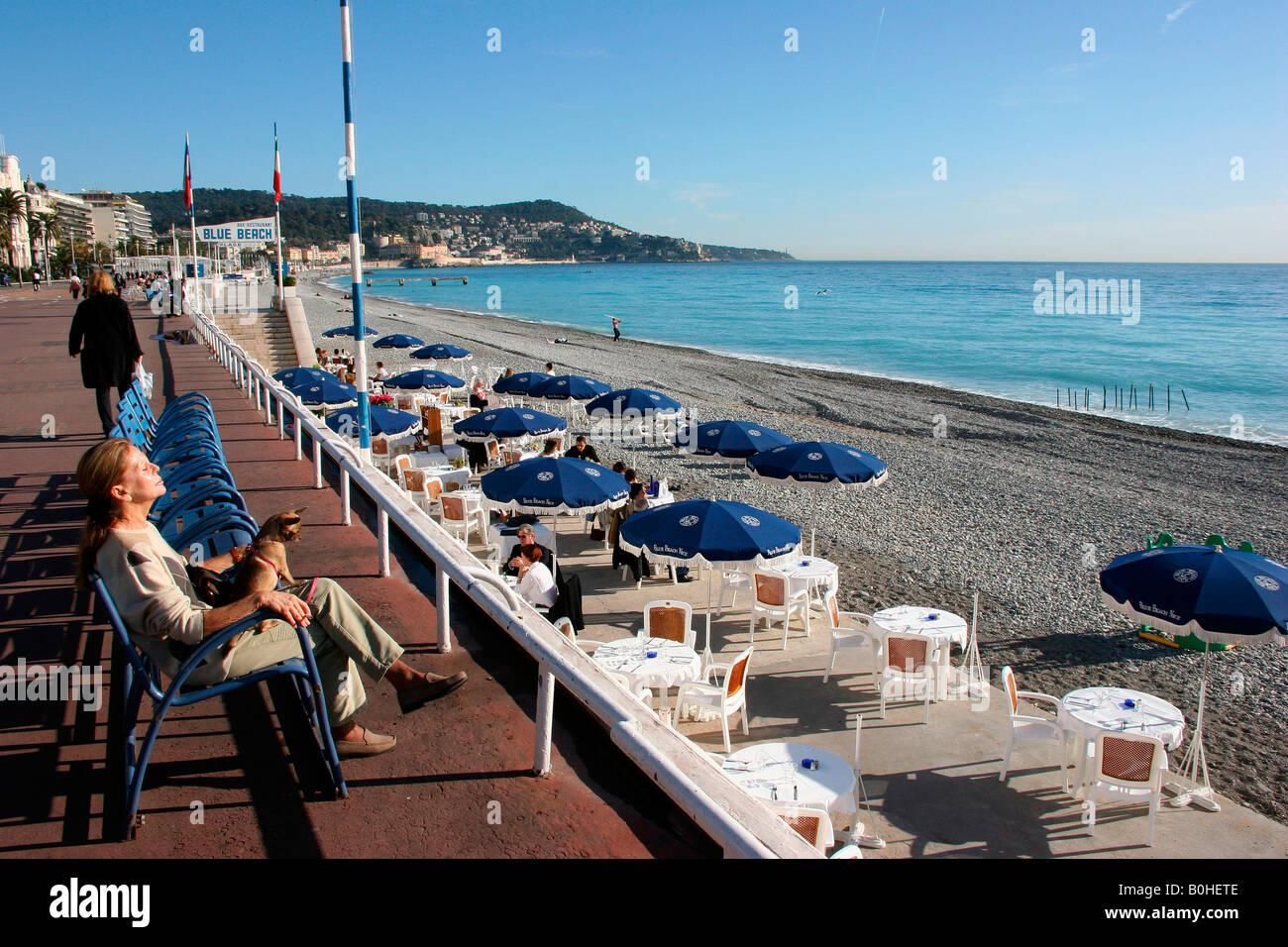 Woman soaking up the sun, beach boardwalk, Promenade des Anglais, Nice ...