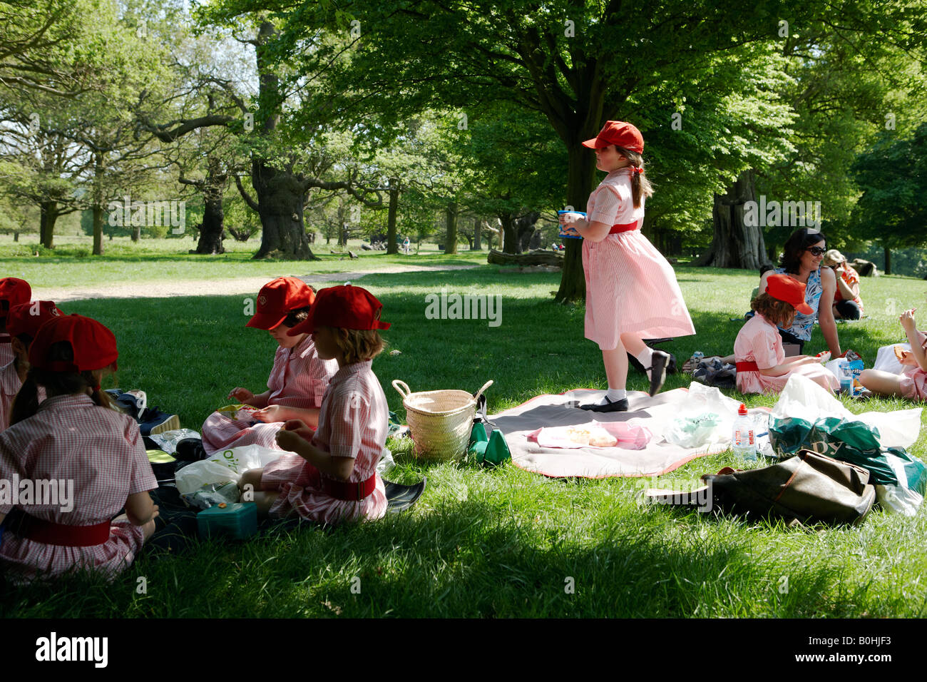 picnic play forest trees uniform girls private school Stock Photo - Alamy