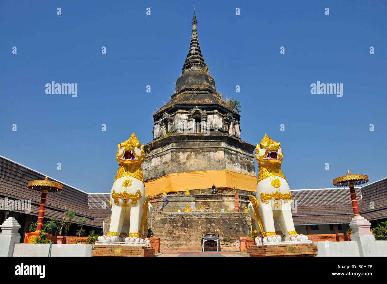 Gilt statues in front of an old stupa, Wat Yaang Kuong Temple, Chiang ...