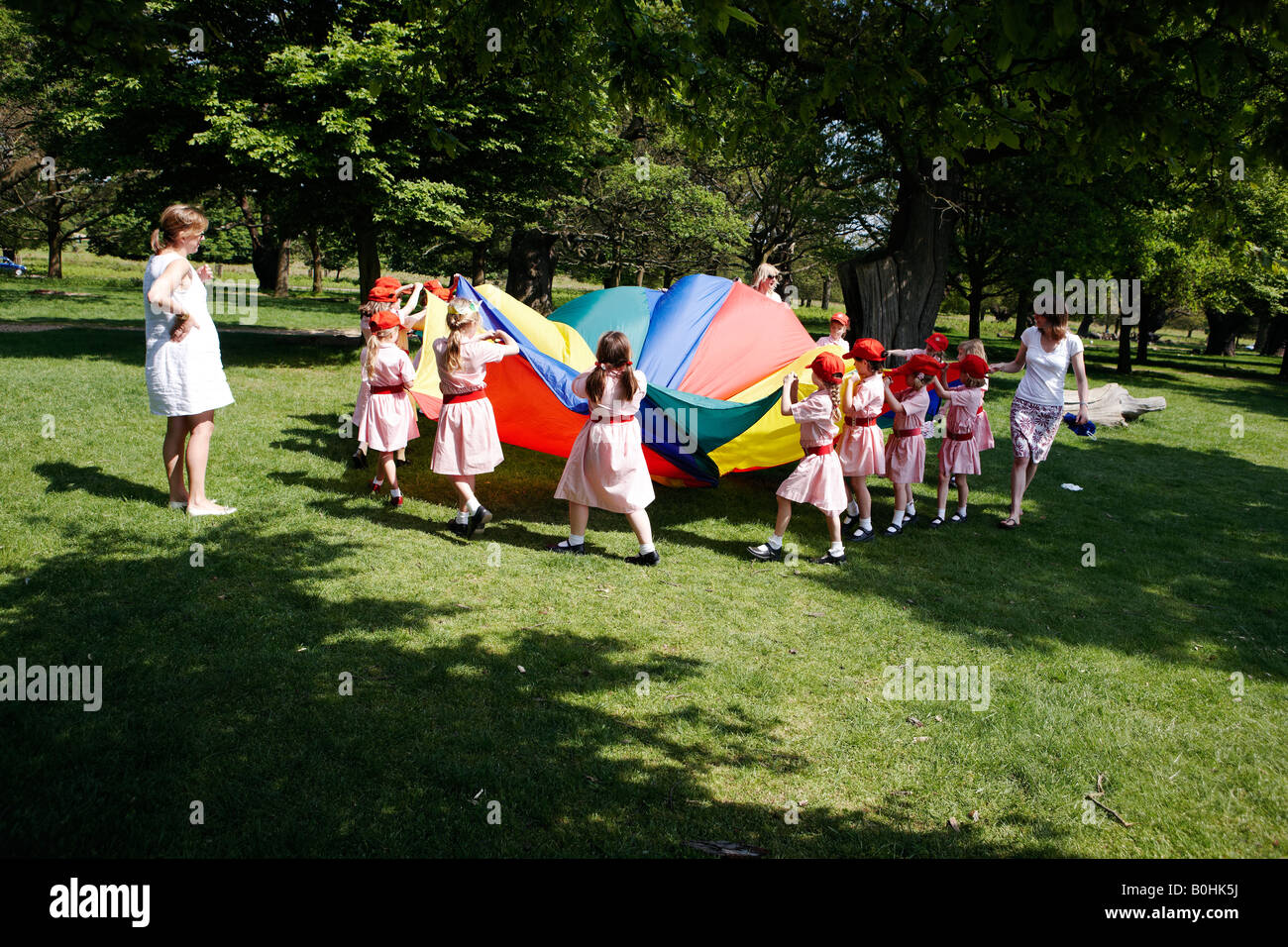 picnic play forest trees uniform girls private school Stock Photo - Alamy