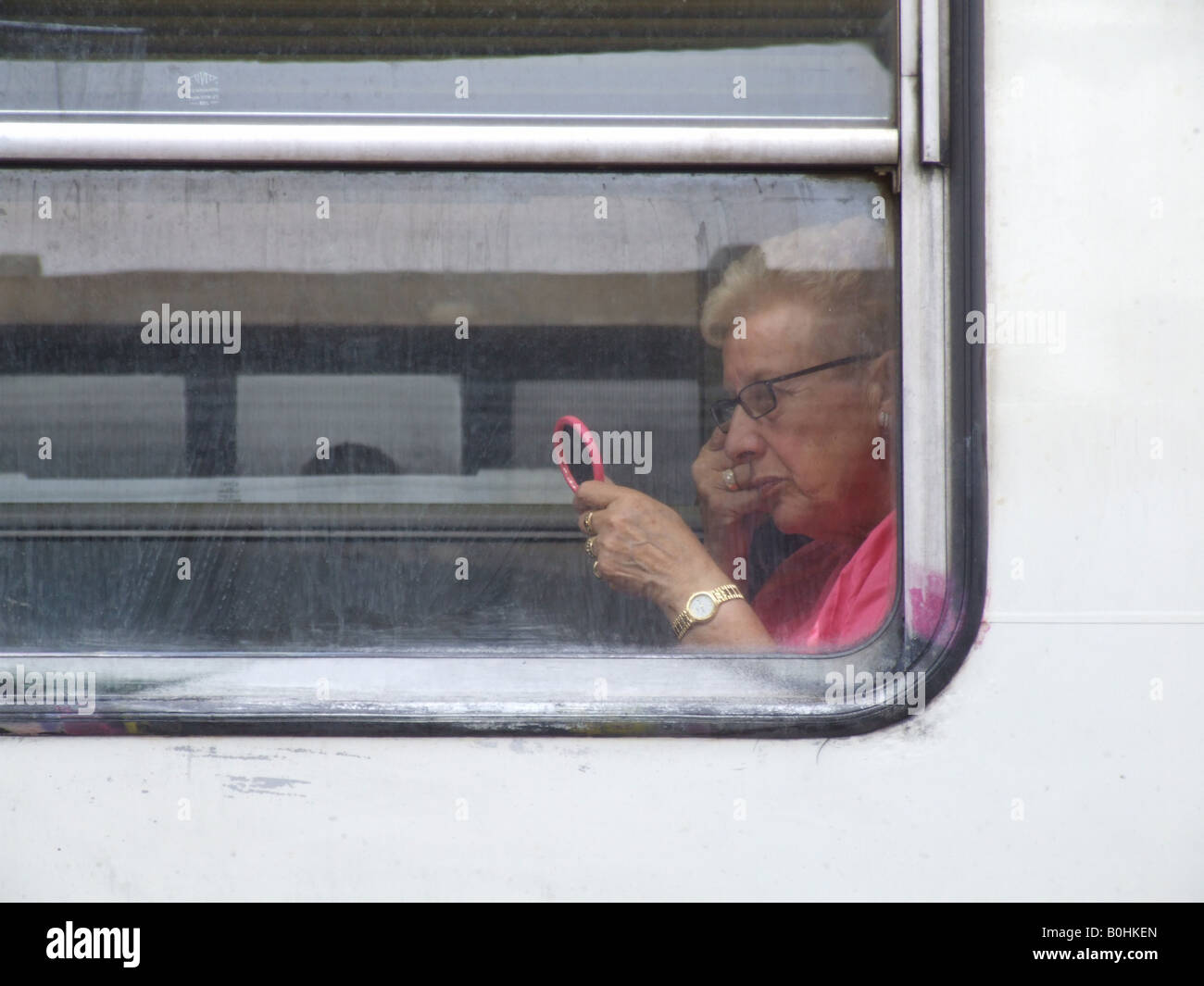 old woman sitting in carriage in train station Stock Photo - Alamy