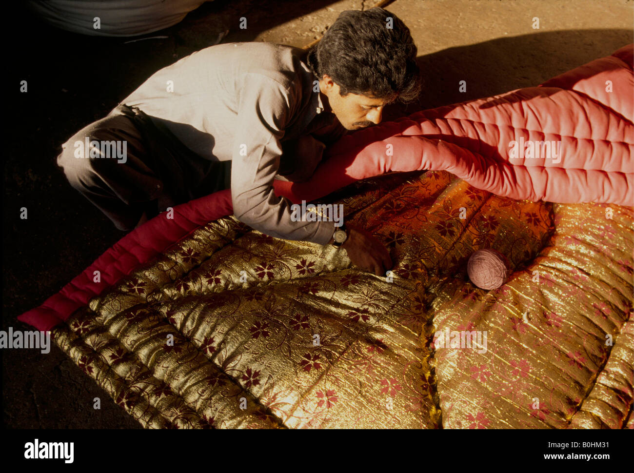 A man sewing designs on a blanket, Quetta, Pakistan Stock Photo - Alamy