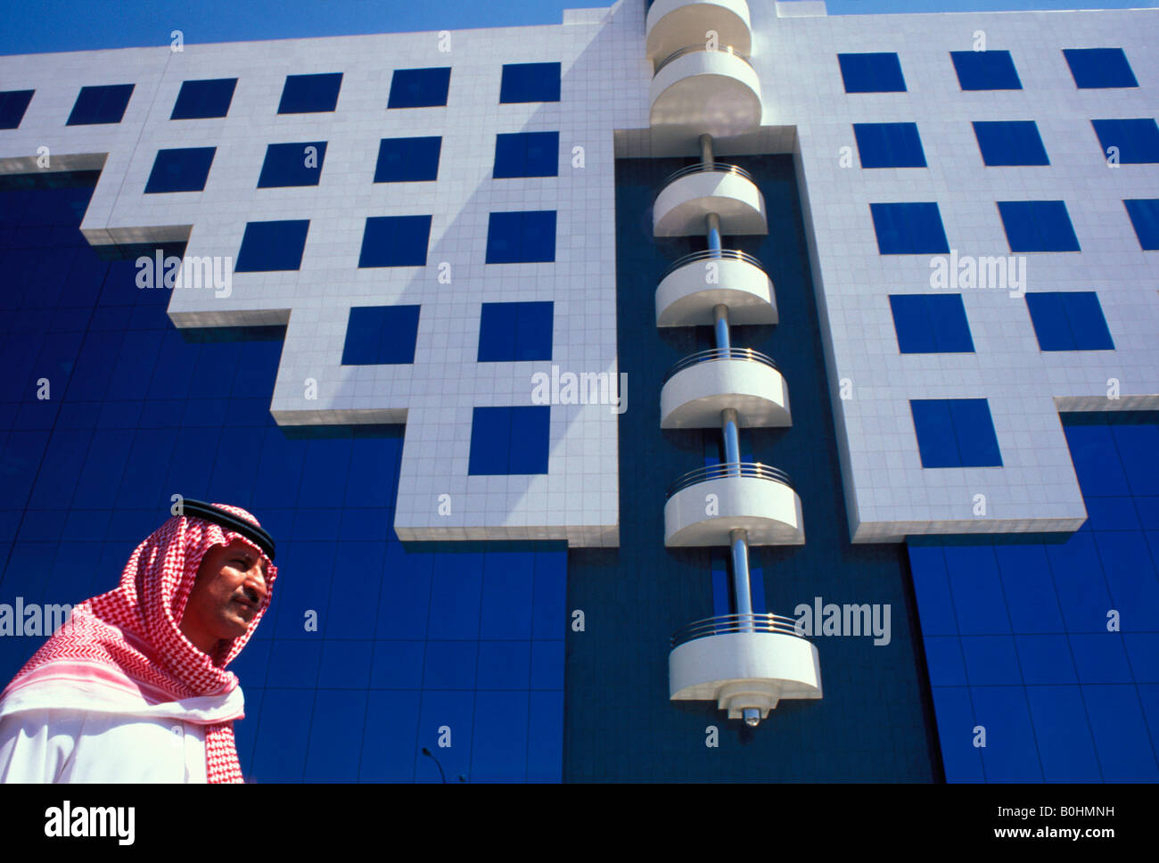 A man walking past a modern office building, Riyadh, Saudi Arabia Stock ...