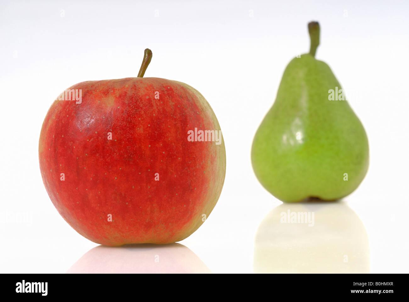 Red apple and green pear Stock Photo - Alamy