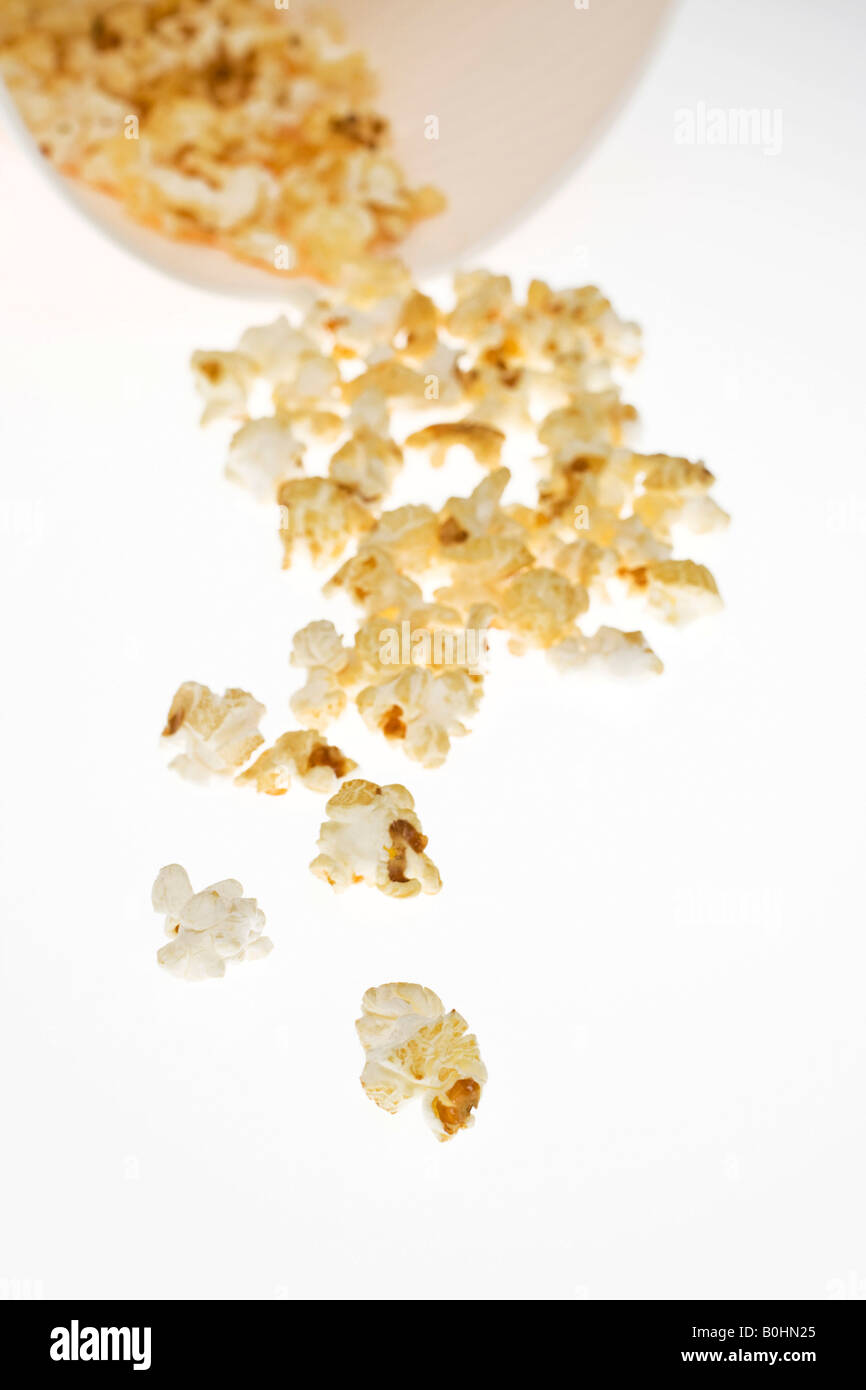 Popcorn spilling out of a bowl Stock Photo - Alamy