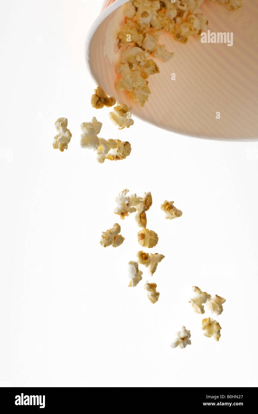 Popcorn spilling out of a bowl Stock Photo - Alamy