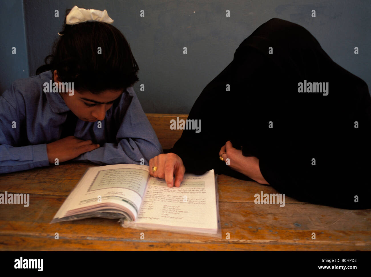 A young Muslim girl being taught religious texts in a classroom, Jordan ...