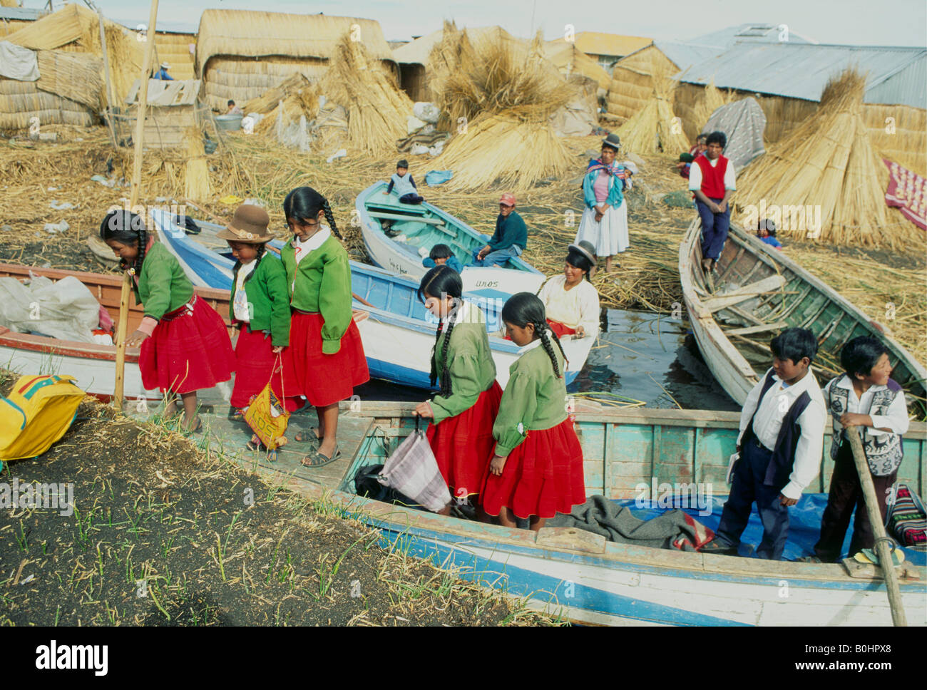 School children travelling home by boat on Lake Titicaca, Uros Islands ...