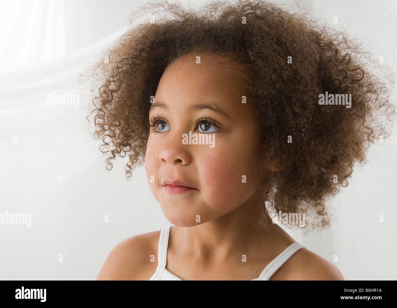 A beautiful adorable young girl with gorgeous Afro hairstyle exposing ...