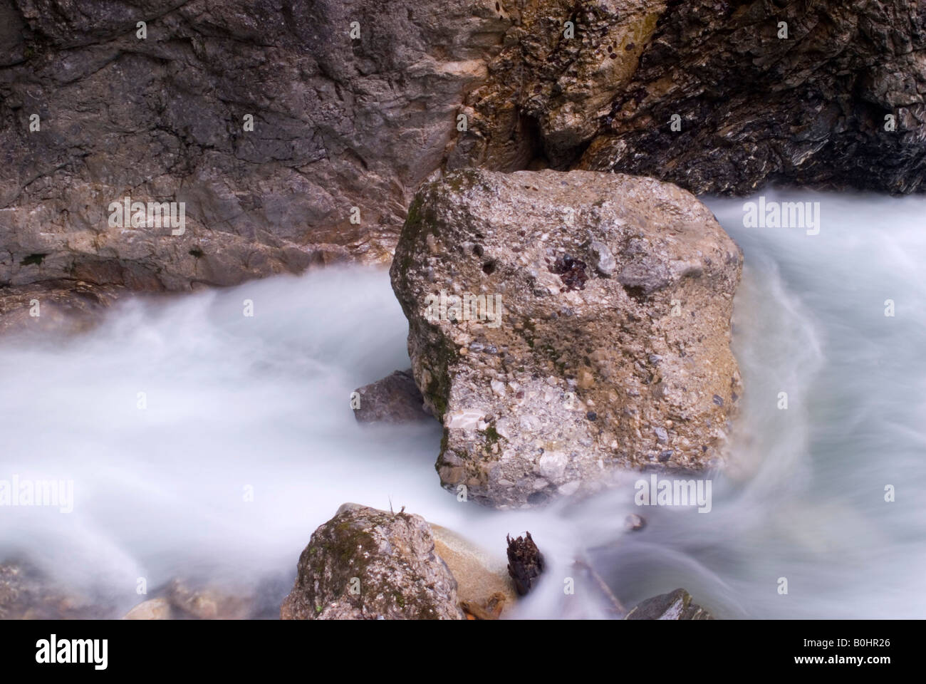 Boulder surrounded by rushing water in the Wolfsklamm Gorge near Stans ...