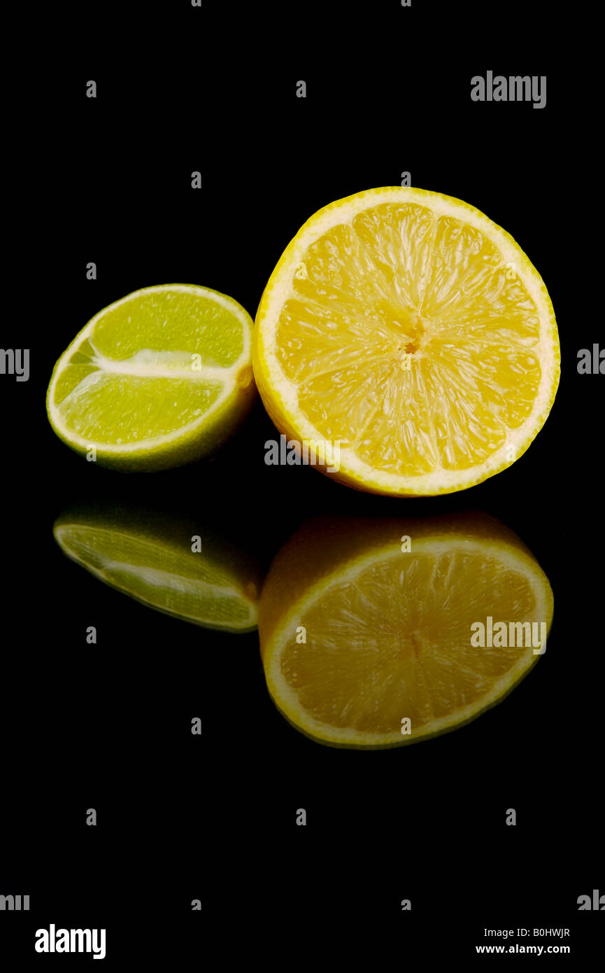 Lemons and limes isolated against a black background Stock Photo - Alamy