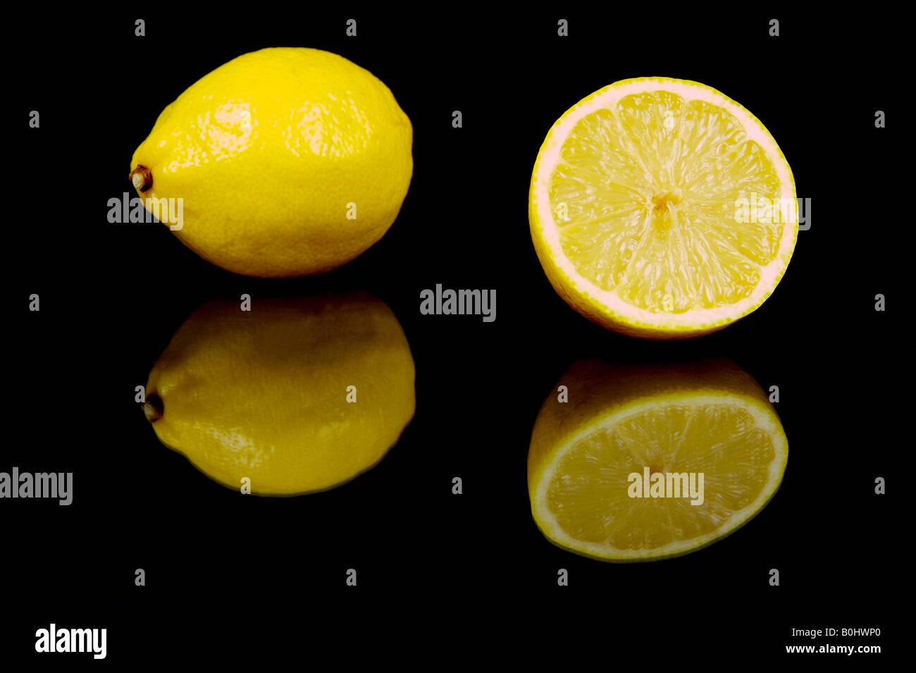 Lemons isolated against a black background Stock Photo - Alamy