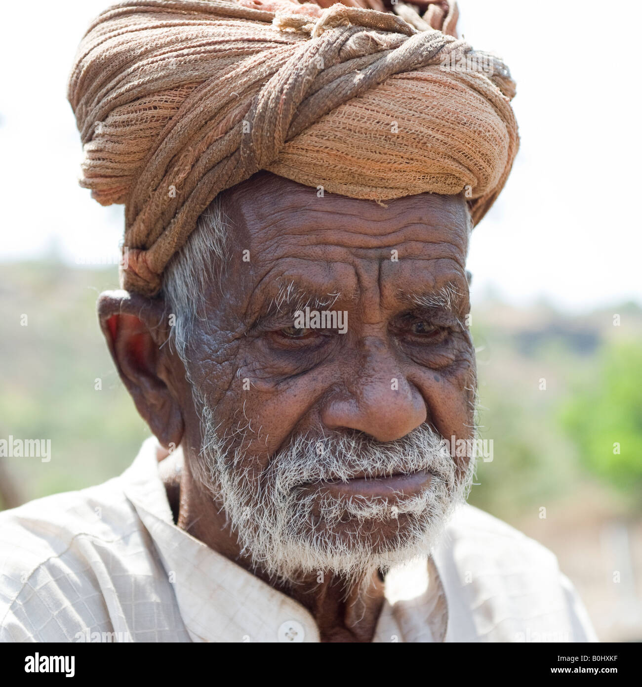 Portrait of an old Indian man, awakening from deep meditation, and ...