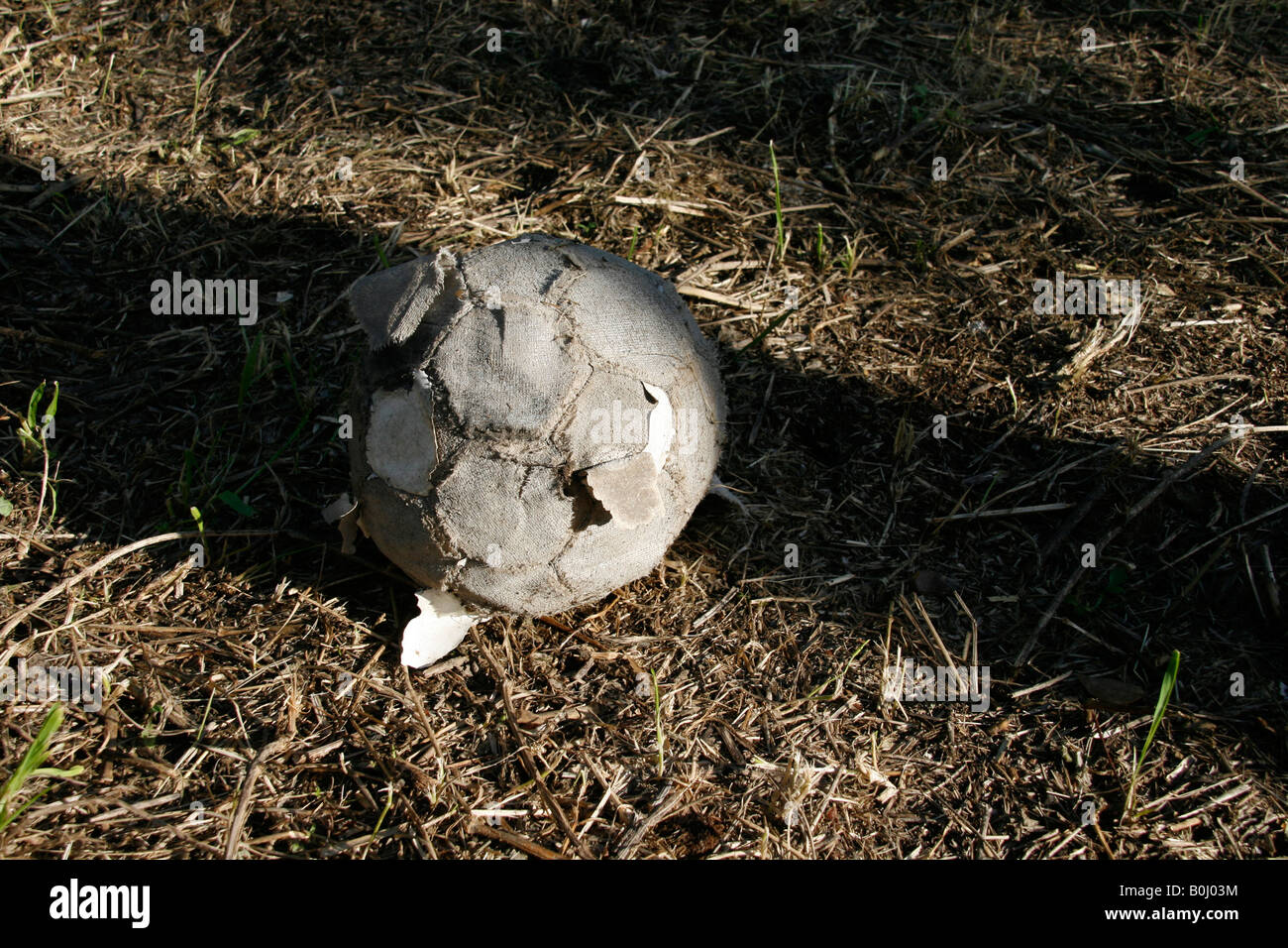 one old damaged football in field Stock Photo - Alamy