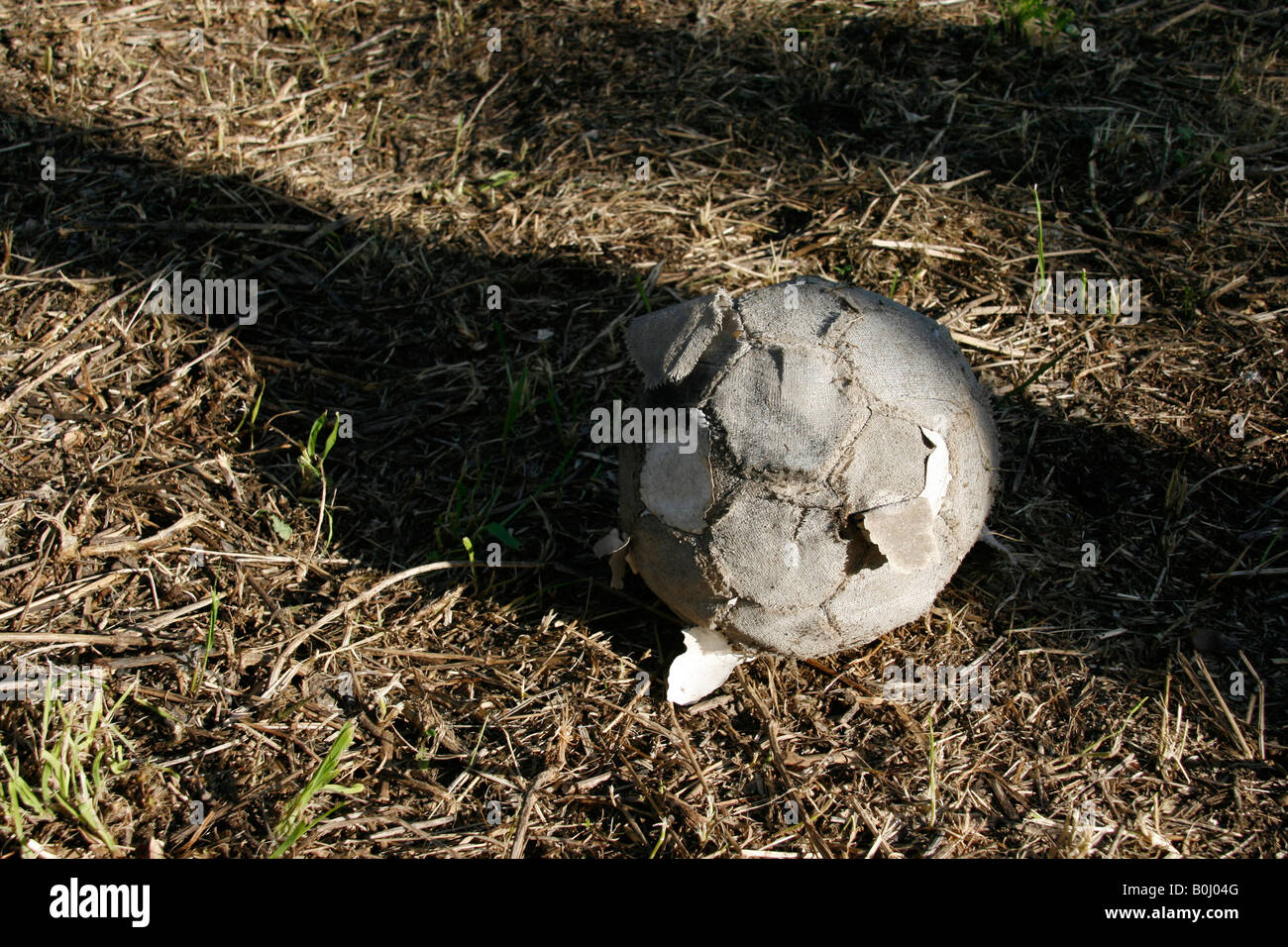 one old damaged football in field Stock Photo - Alamy