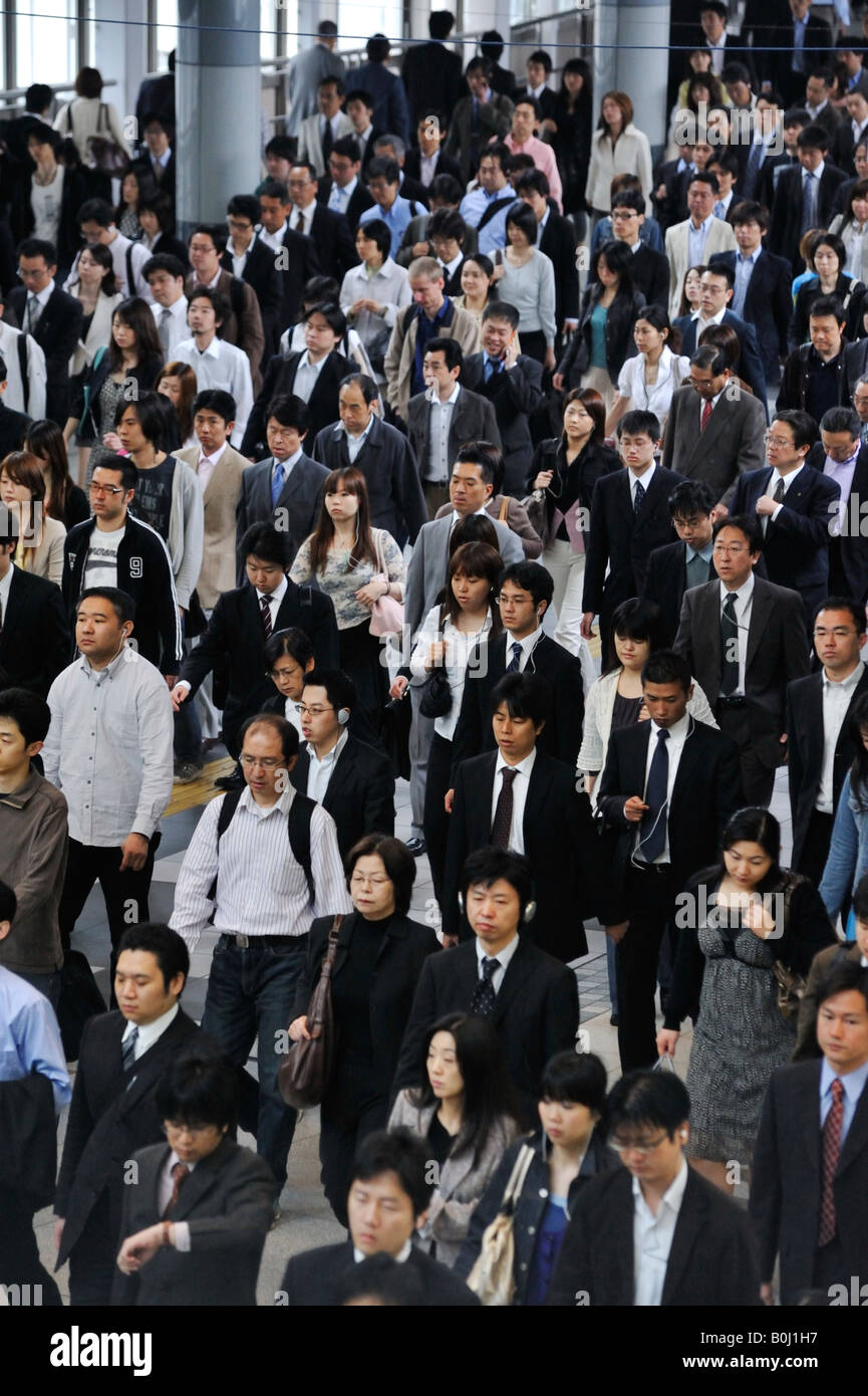 Crowd of commuters walking to work during morning rush hour in railway ...