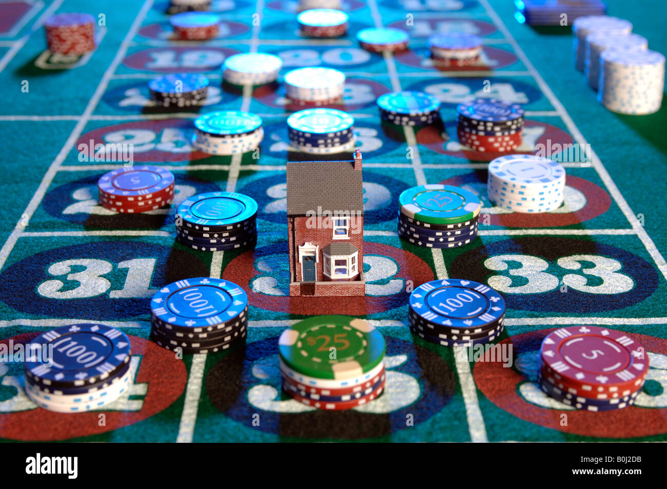 a model of a house being gambled on a roulette table Stock Photo - Alamy