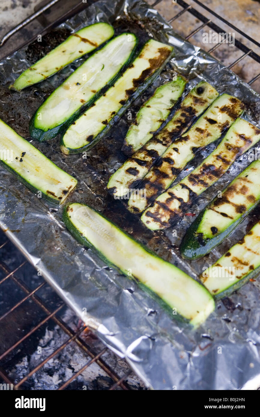 Sliced courgette/ zucchini cooking on the barbecue Stock Photo - Alamy