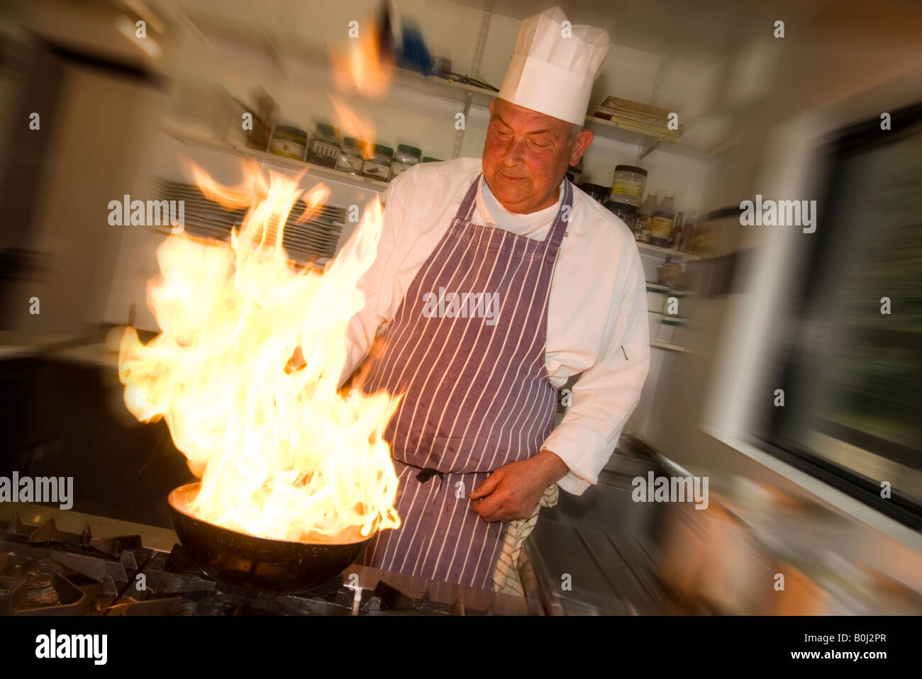 chef with flaming pan Stock Photo - Alamy