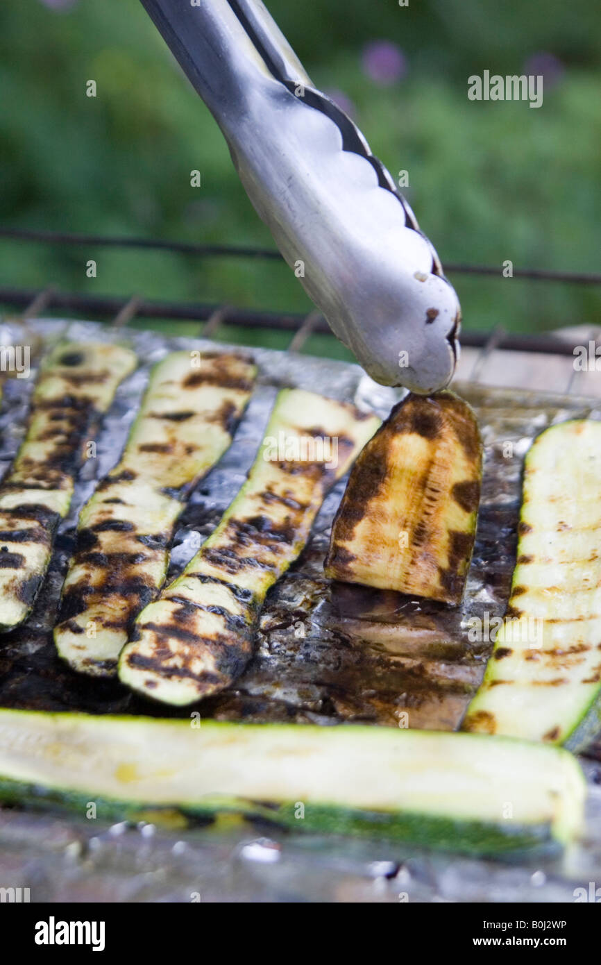 Sliced courgette/ zucchini cooking on the barbecue Stock Photo - Alamy