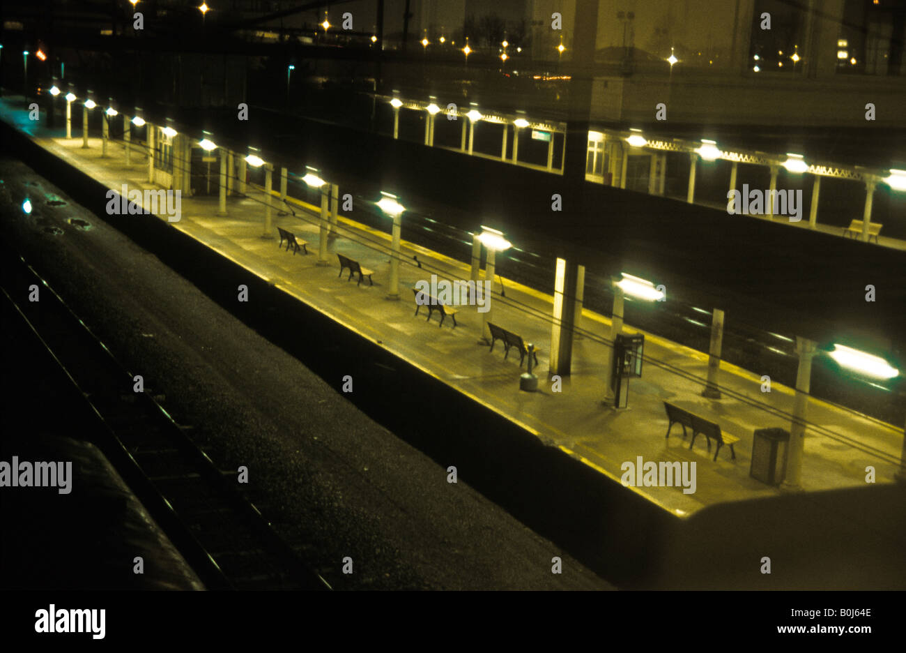 Railroad train station platform benches at night. City scene Stock ...