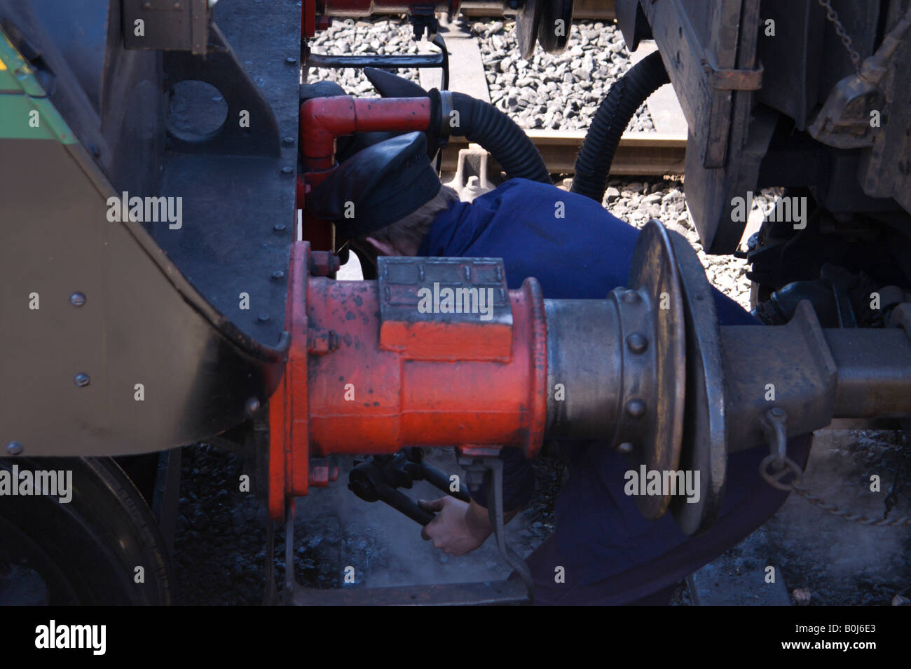 Coupling steam engine (locomotive) to carriages on the Bluebell Railway ...