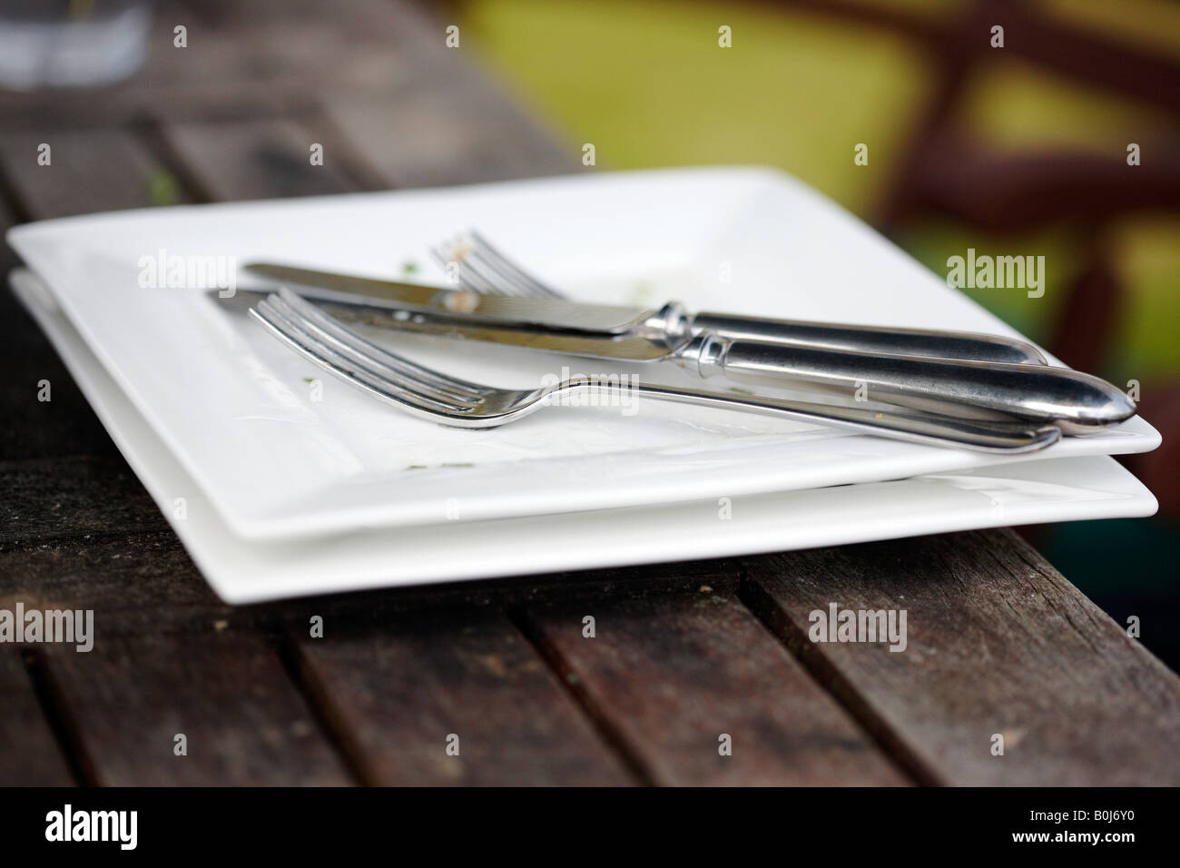 Square dinner plates, on garden table Stock Photo - Alamy