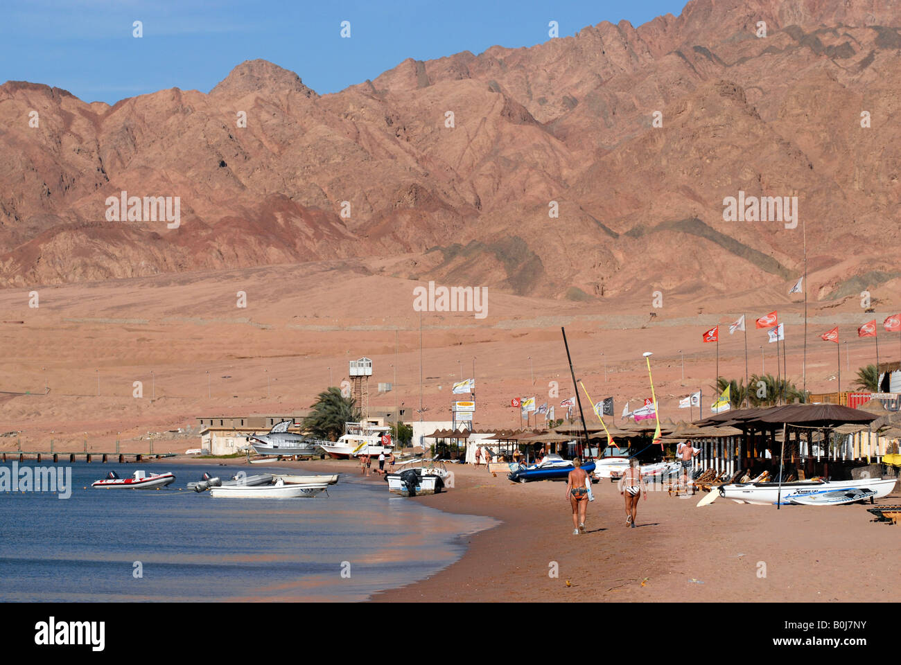 Tourists on the beach at the Dahab holiday resort with the Sinai ...