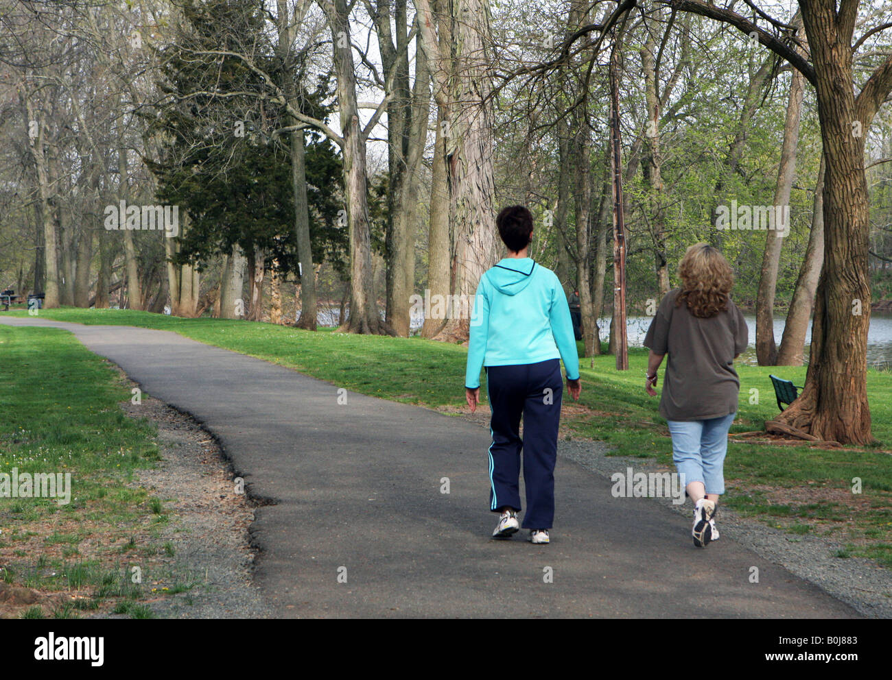 Two women walking in the park Stock Photo - Alamy