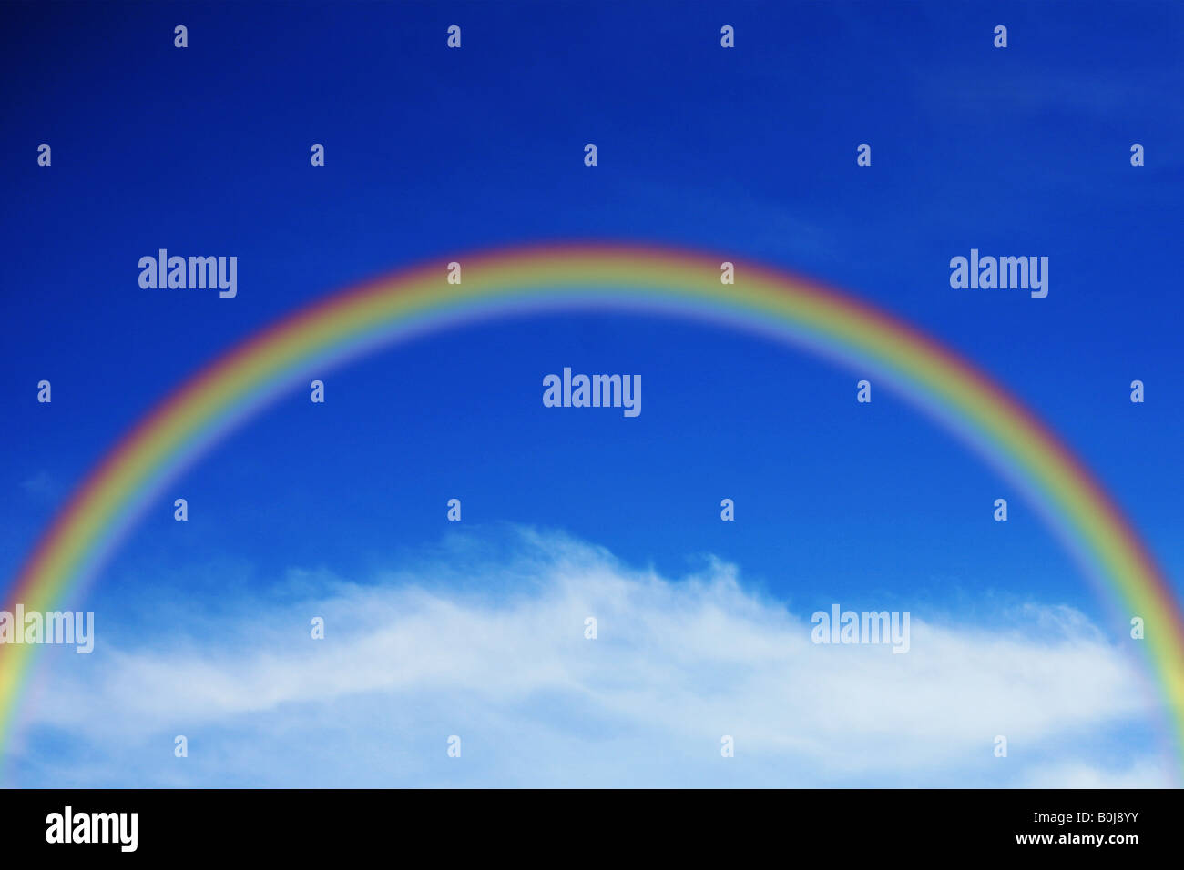 Rainbow in the bright blue summer sky Stock Photo - Alamy