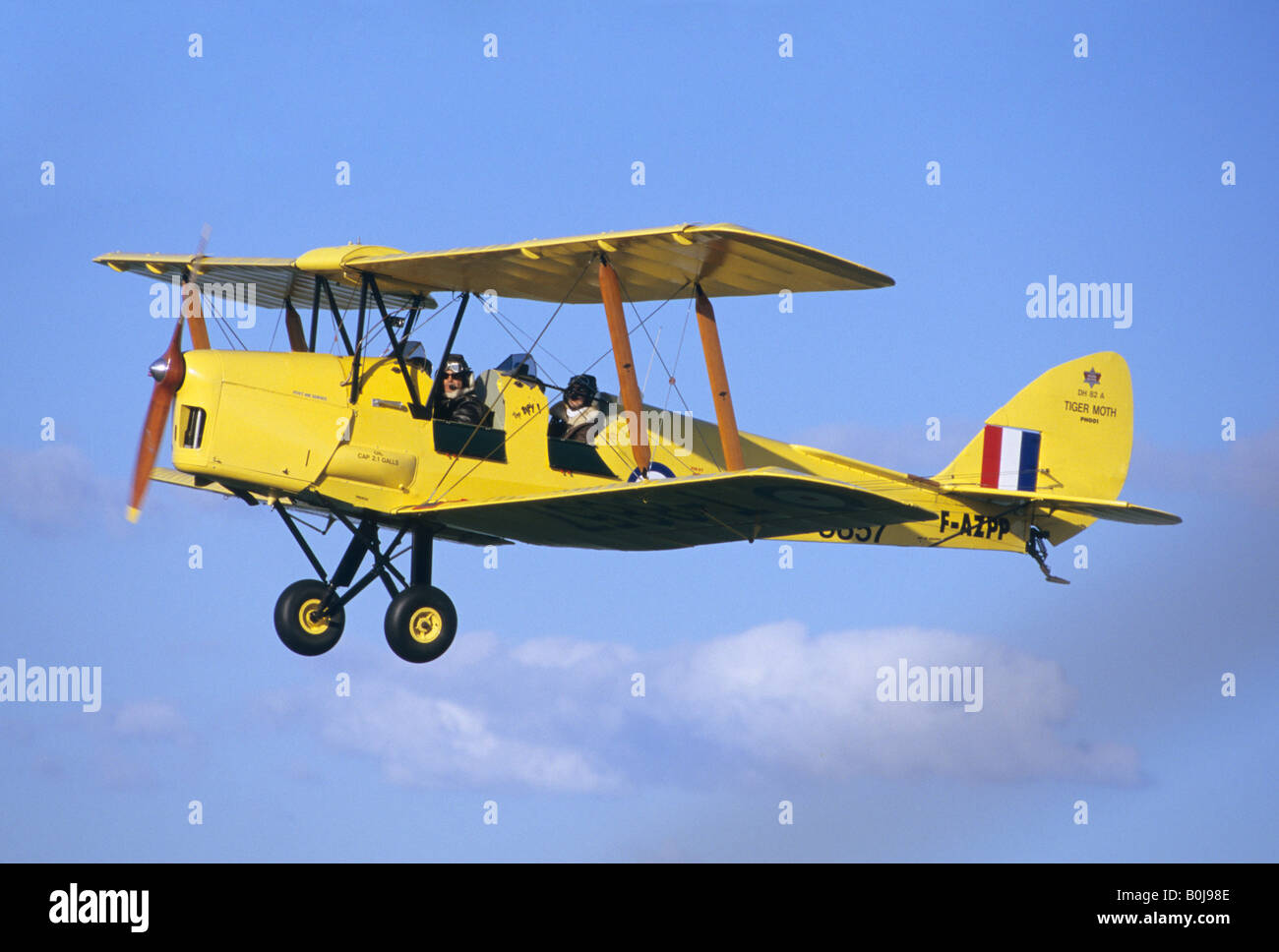 Old British trainer biplane De Havilland DH-82c Tiger Moth in flight ...