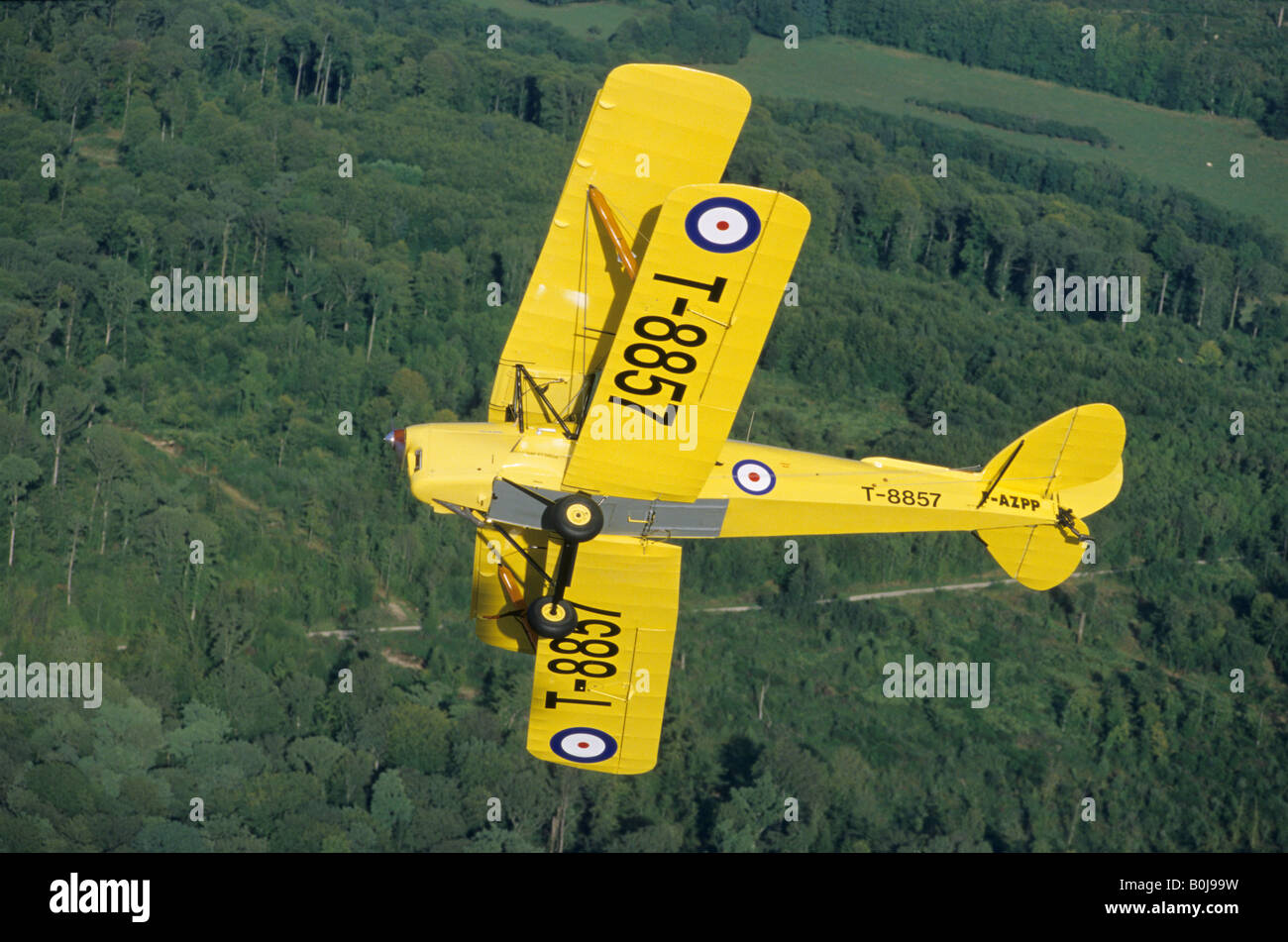 Old British trainer biplane De Havilland DH-82c Tiger Moth in flight ...