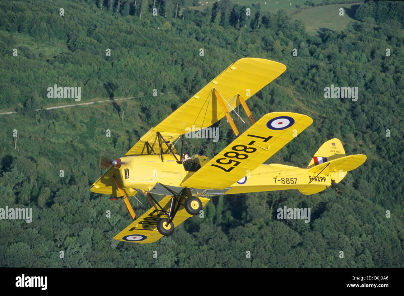 Old British trainer biplane De Havilland DH-82c Tiger Moth in flight ...