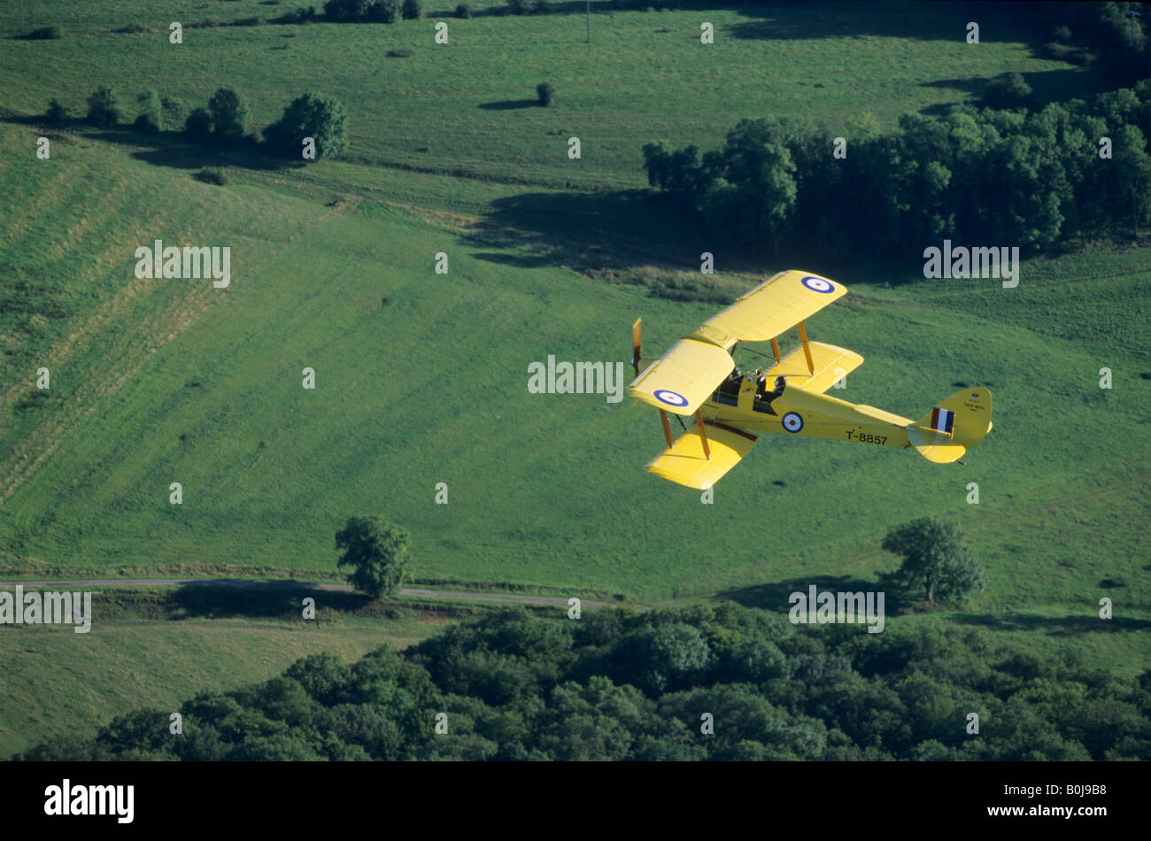 Old British trainer biplane De Havilland DH-82c Tiger Moth in flight ...