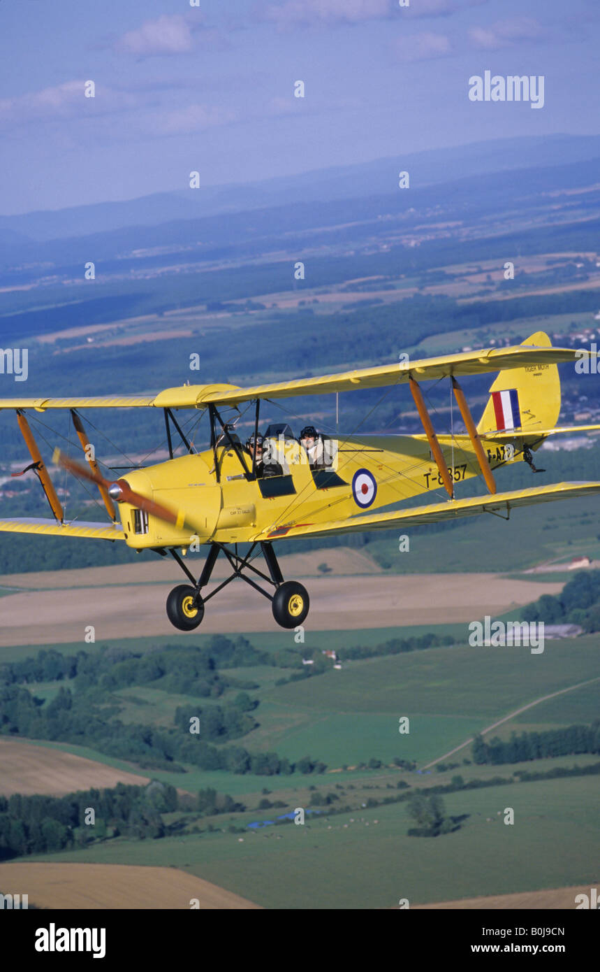 Old British trainer biplane De Havilland DH-82c Tiger Moth in flight ...